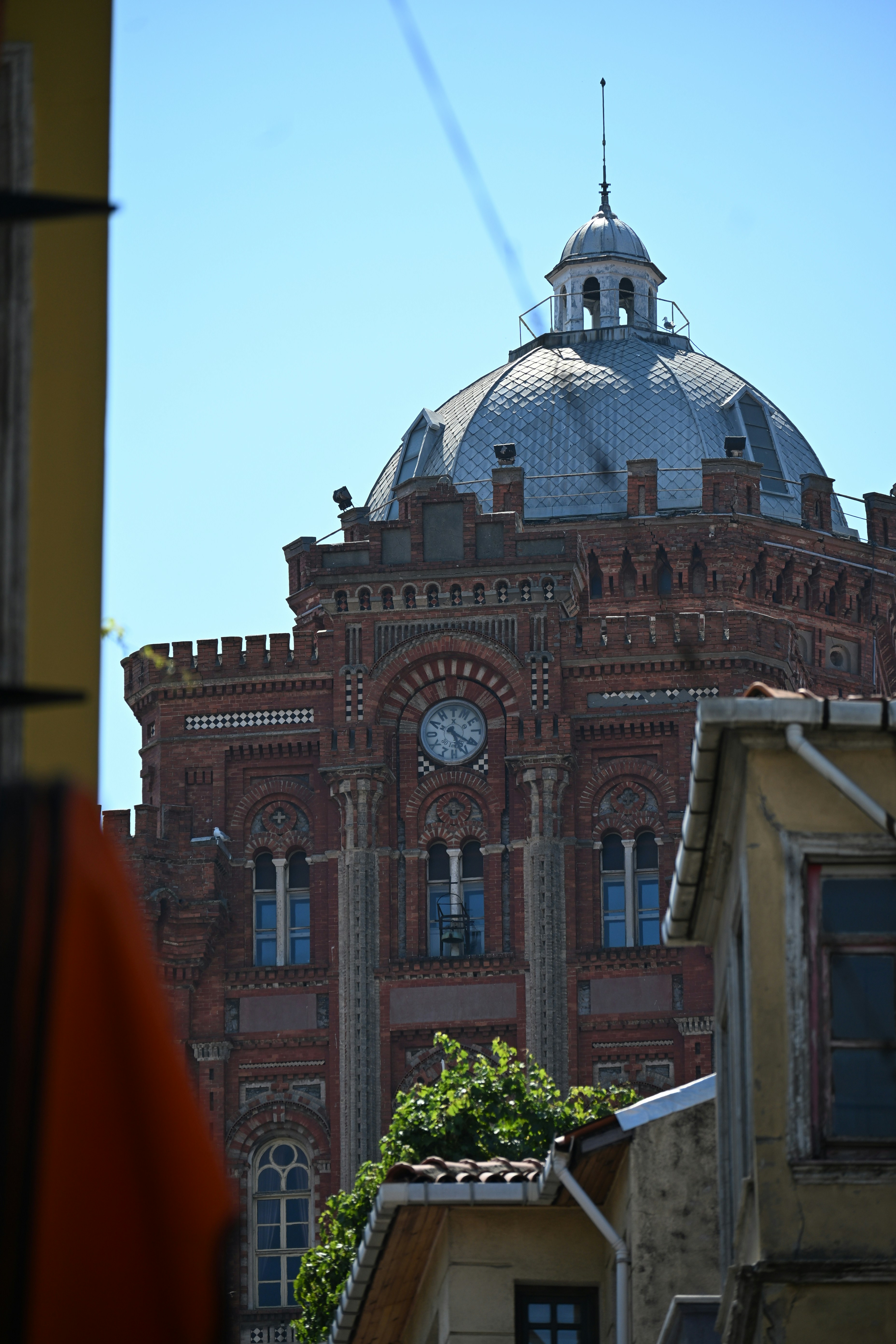 Brick Clocktower Beneath a Metal Dome