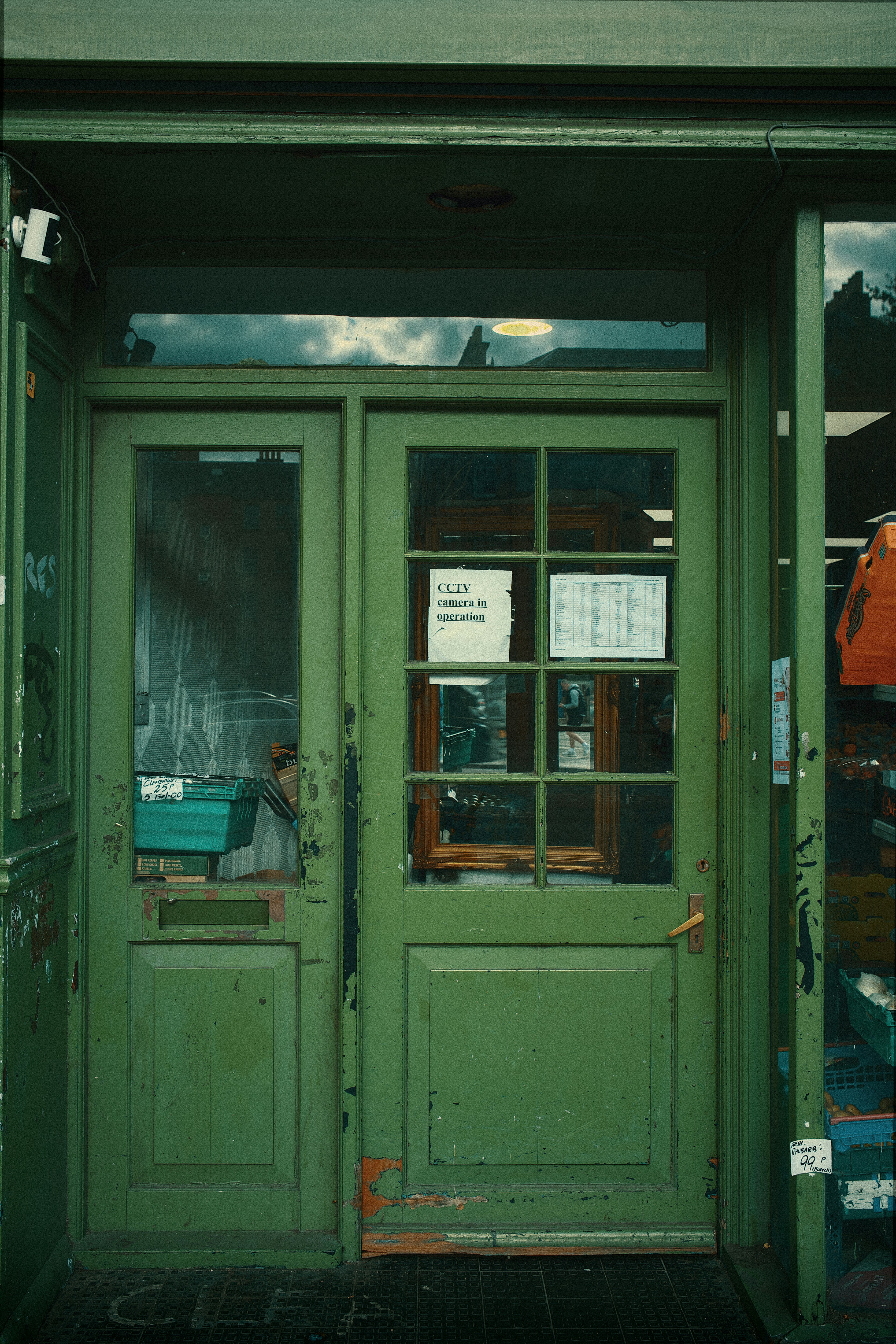 Green Portal: A Worn Doorway into the City’s Quiet Corner