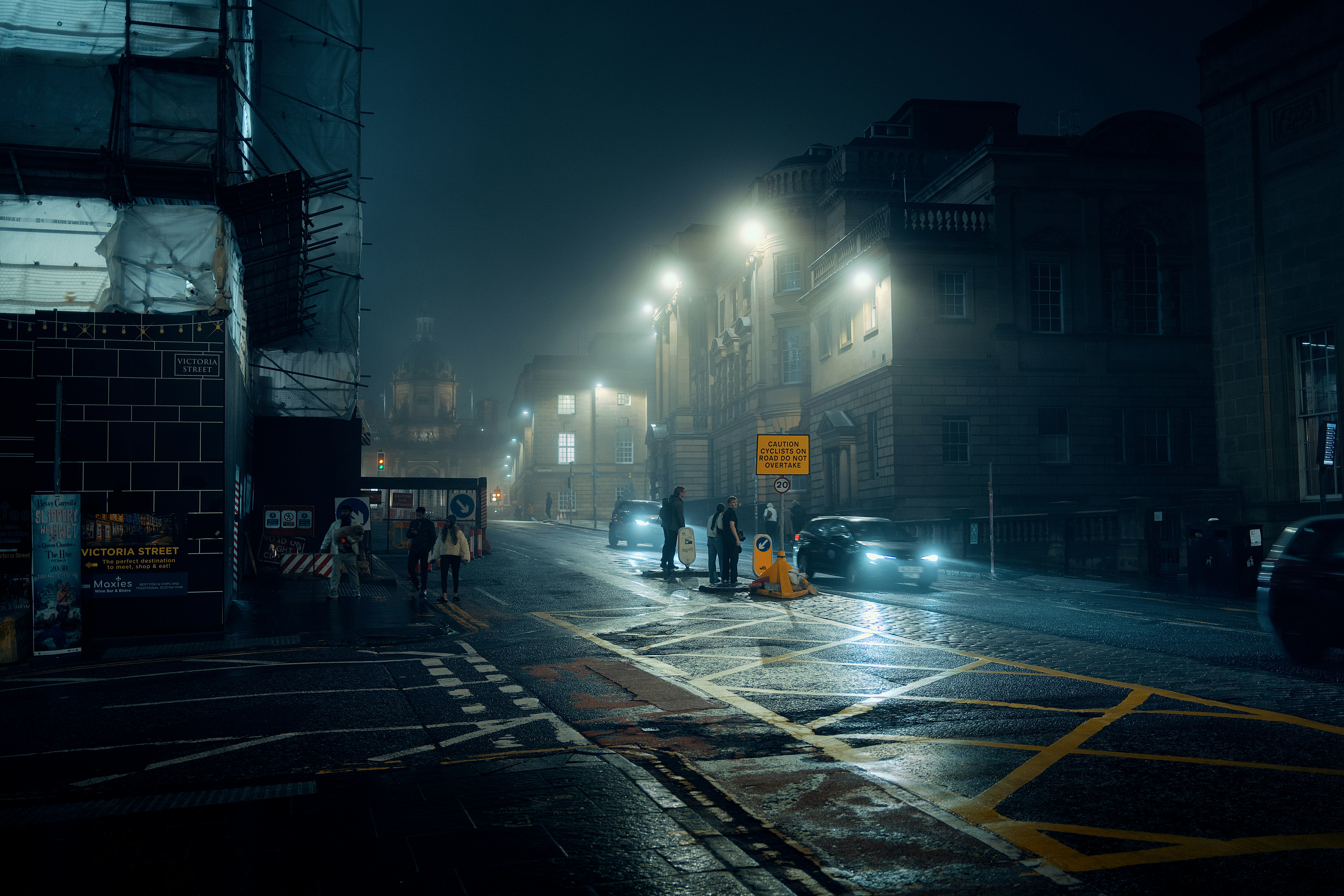 Rain-Slicked Street Under Neon Vigil: Night Shoppers and Rising Steam