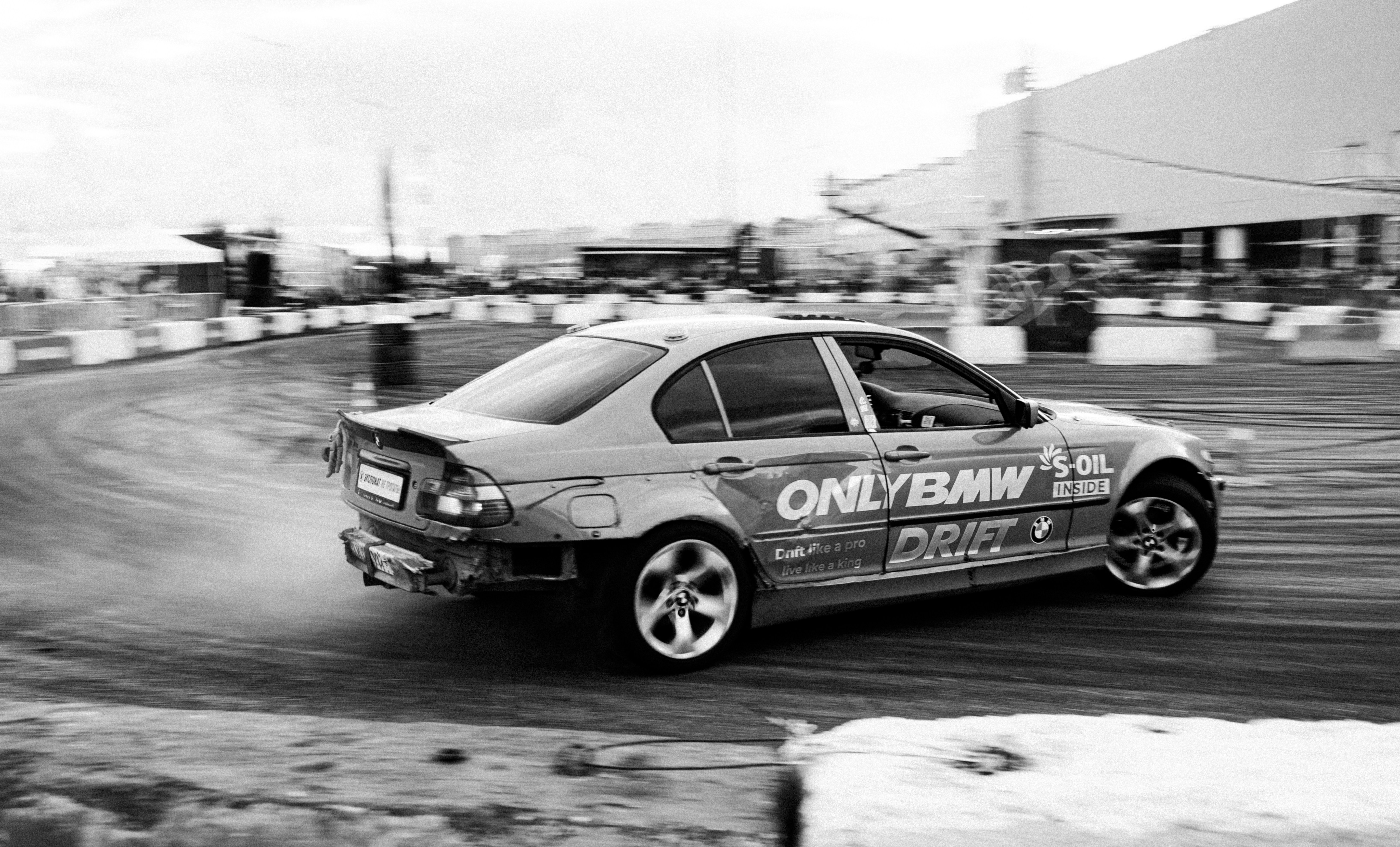 Drifted Shadow: A BMW on the Edge of the Track