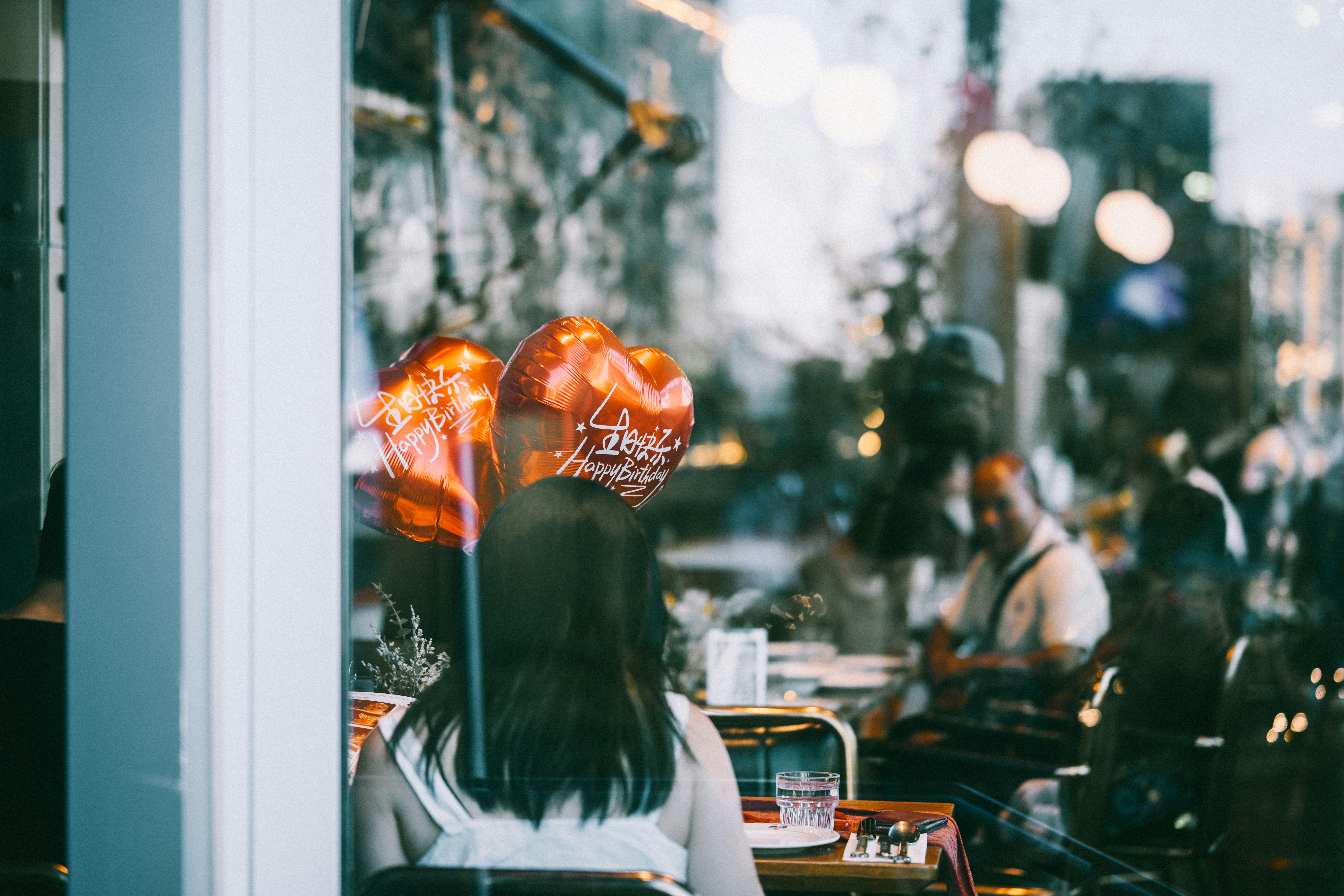Through a Window of Warm Ambience: Balloons and Quiet Conversation