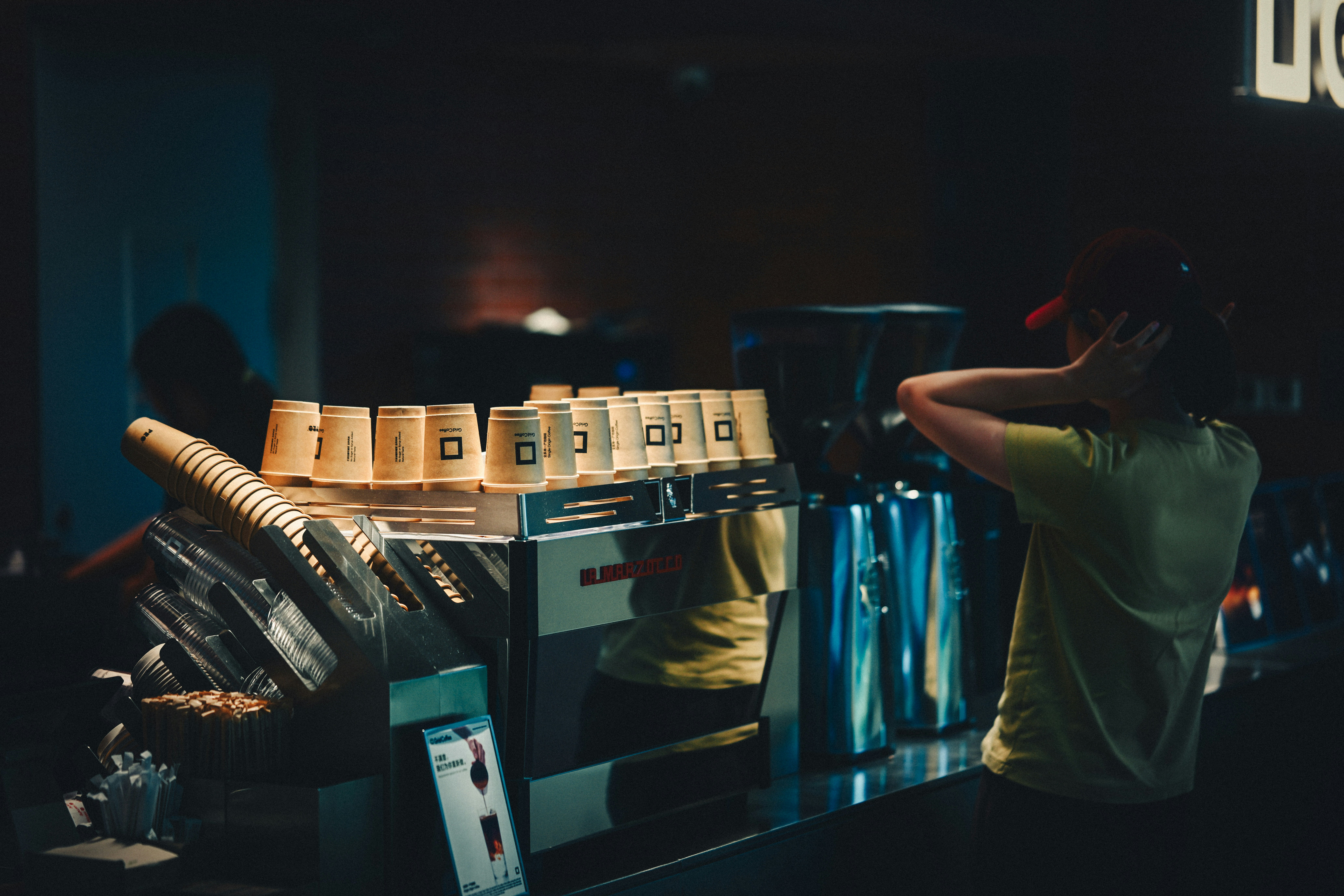 Neon-lit Coffee Counter: Steam, Cups, and a Quiet Reflection