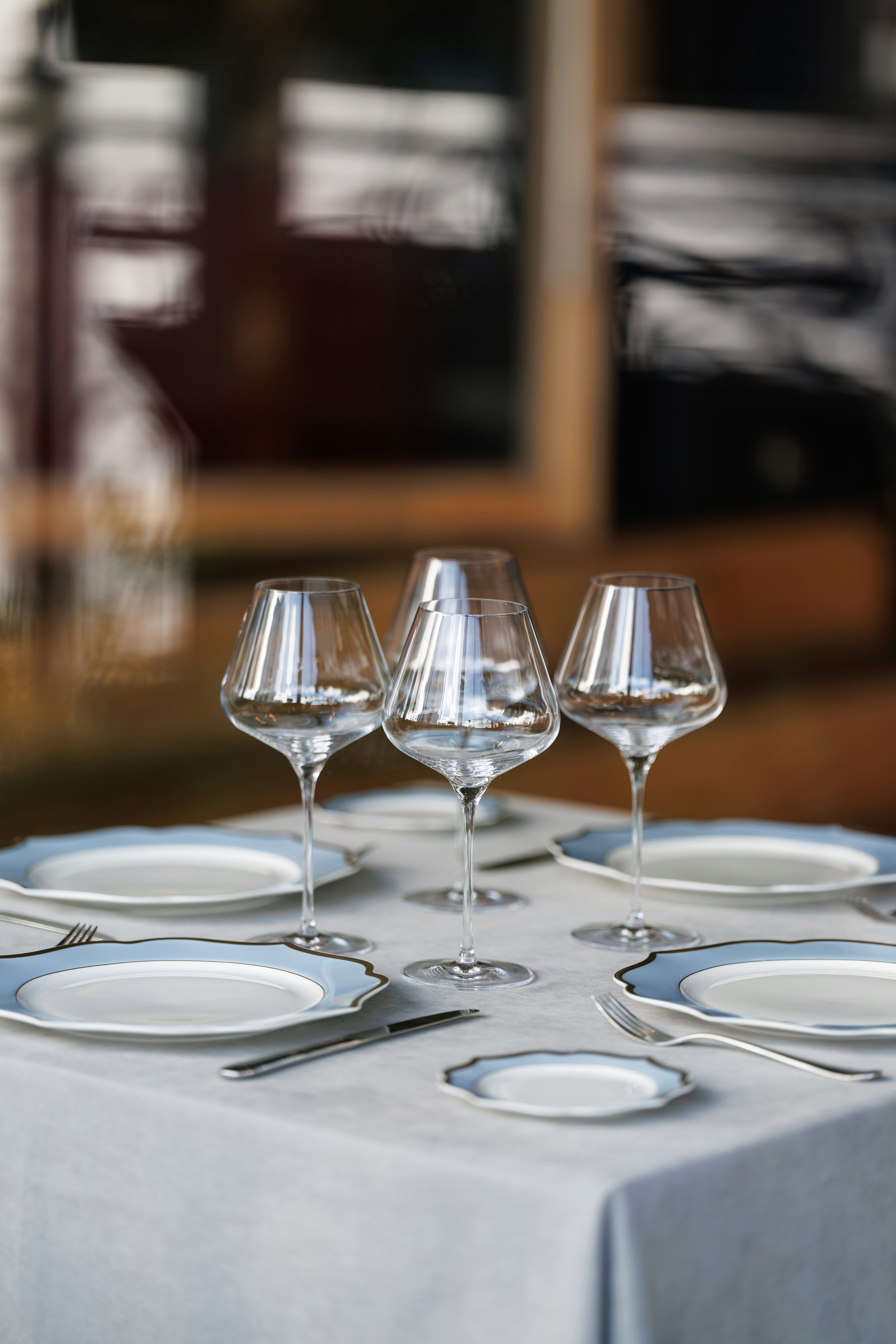 Three Stemmed Glasses Guard a Quiet Table