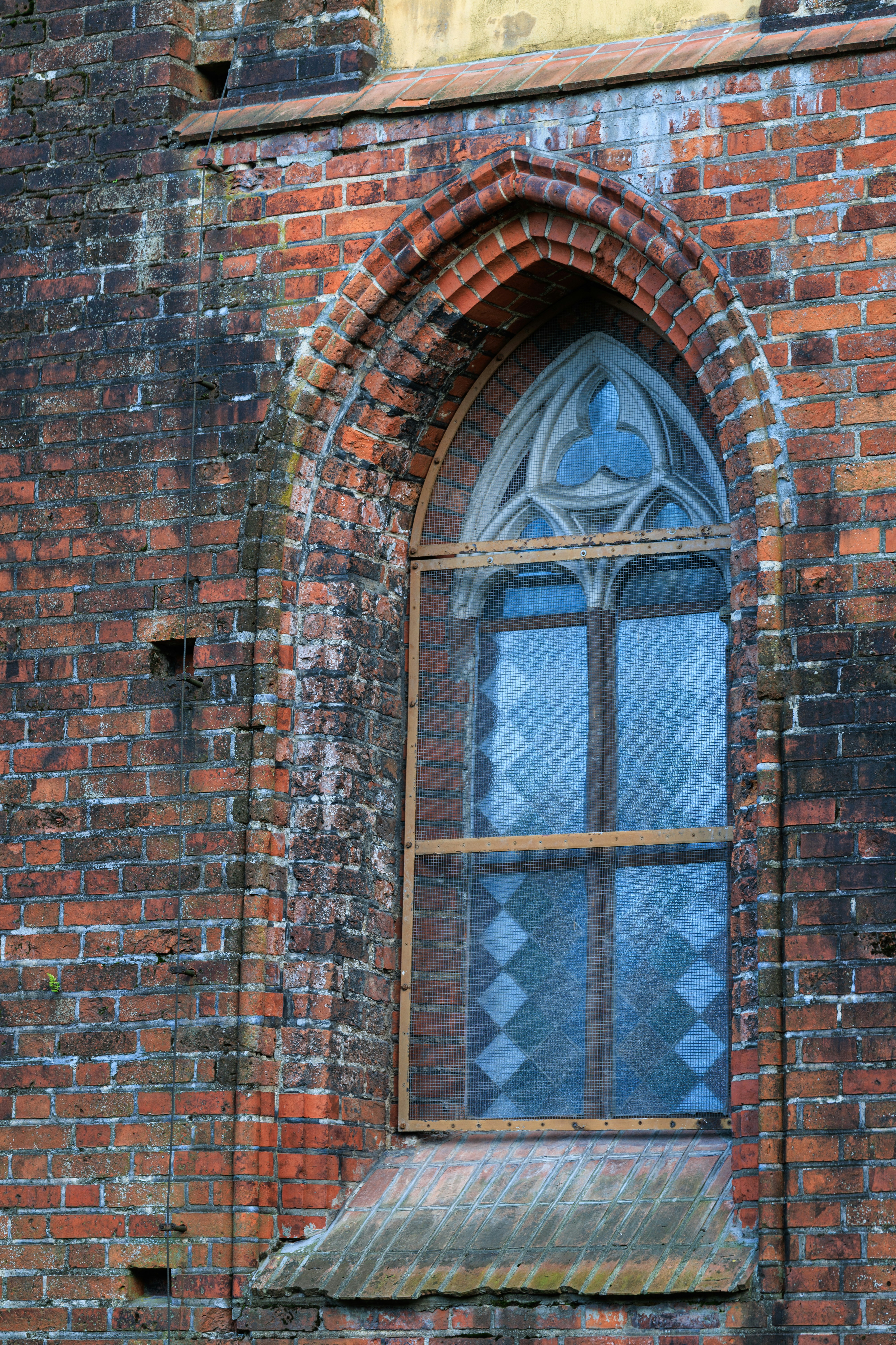 Gothic Brick Archway Framing a Segmented Window