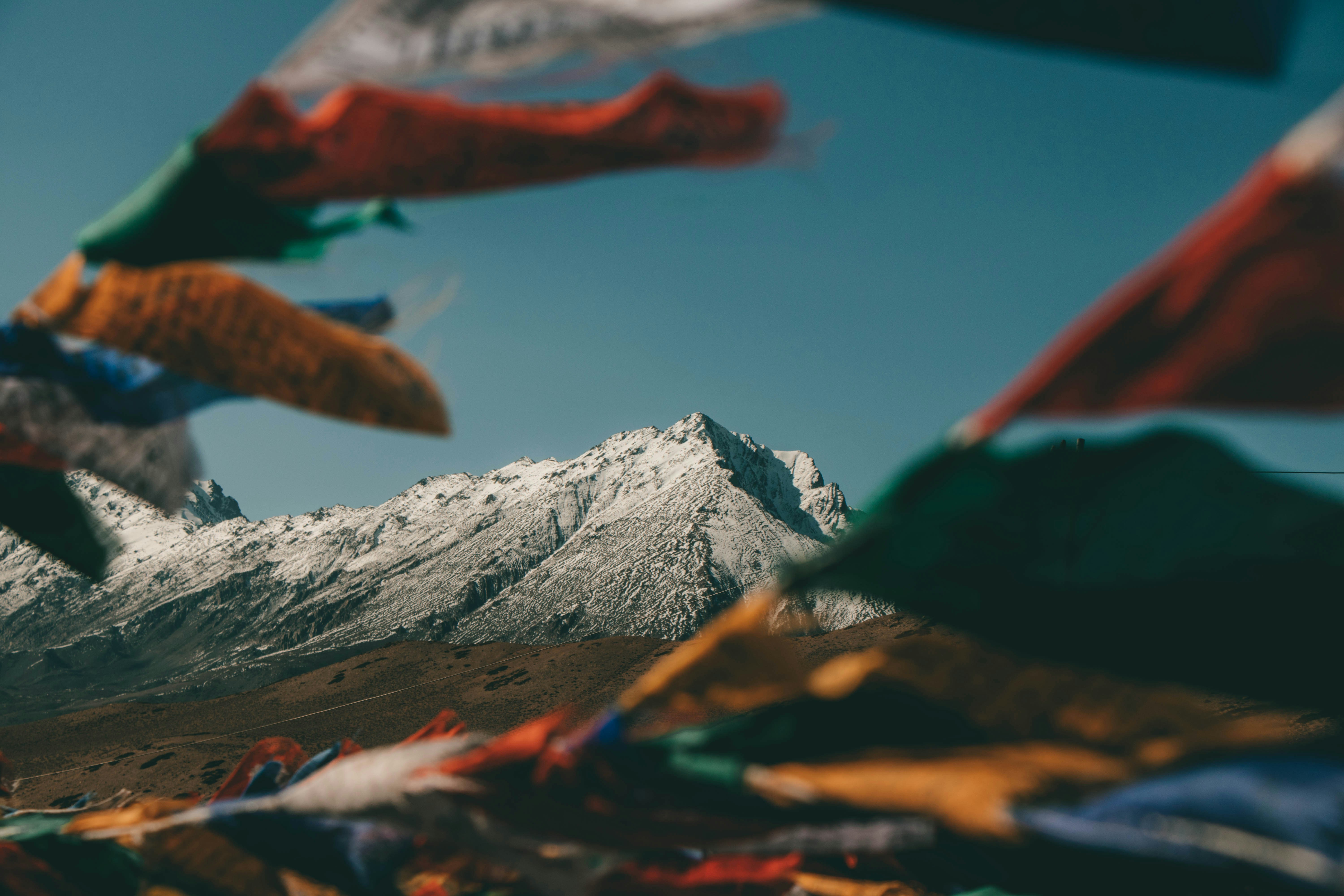 Prayer Flags Framing a Snow-Capped Summit