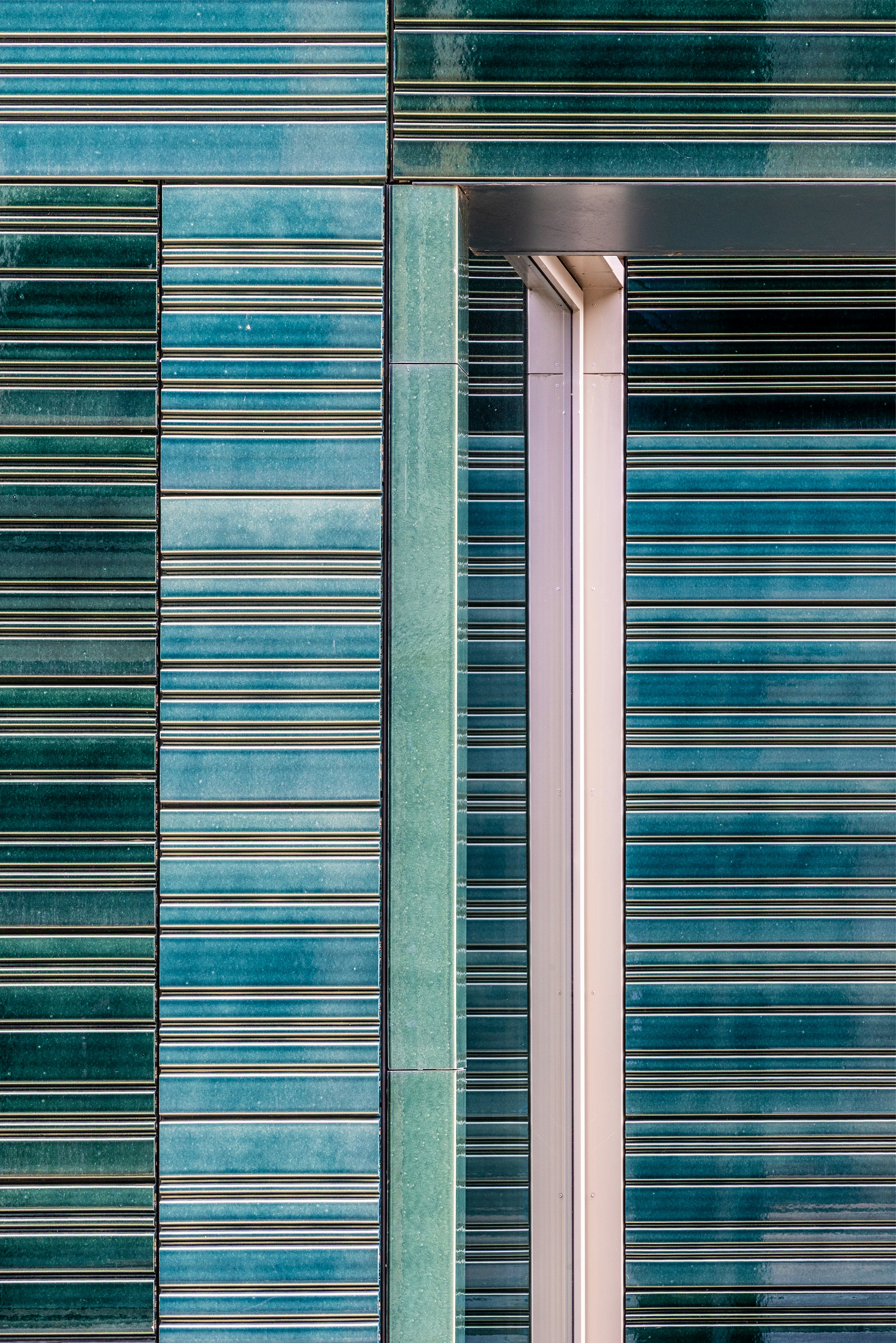 Ridge of teal tiles and a slender doorway