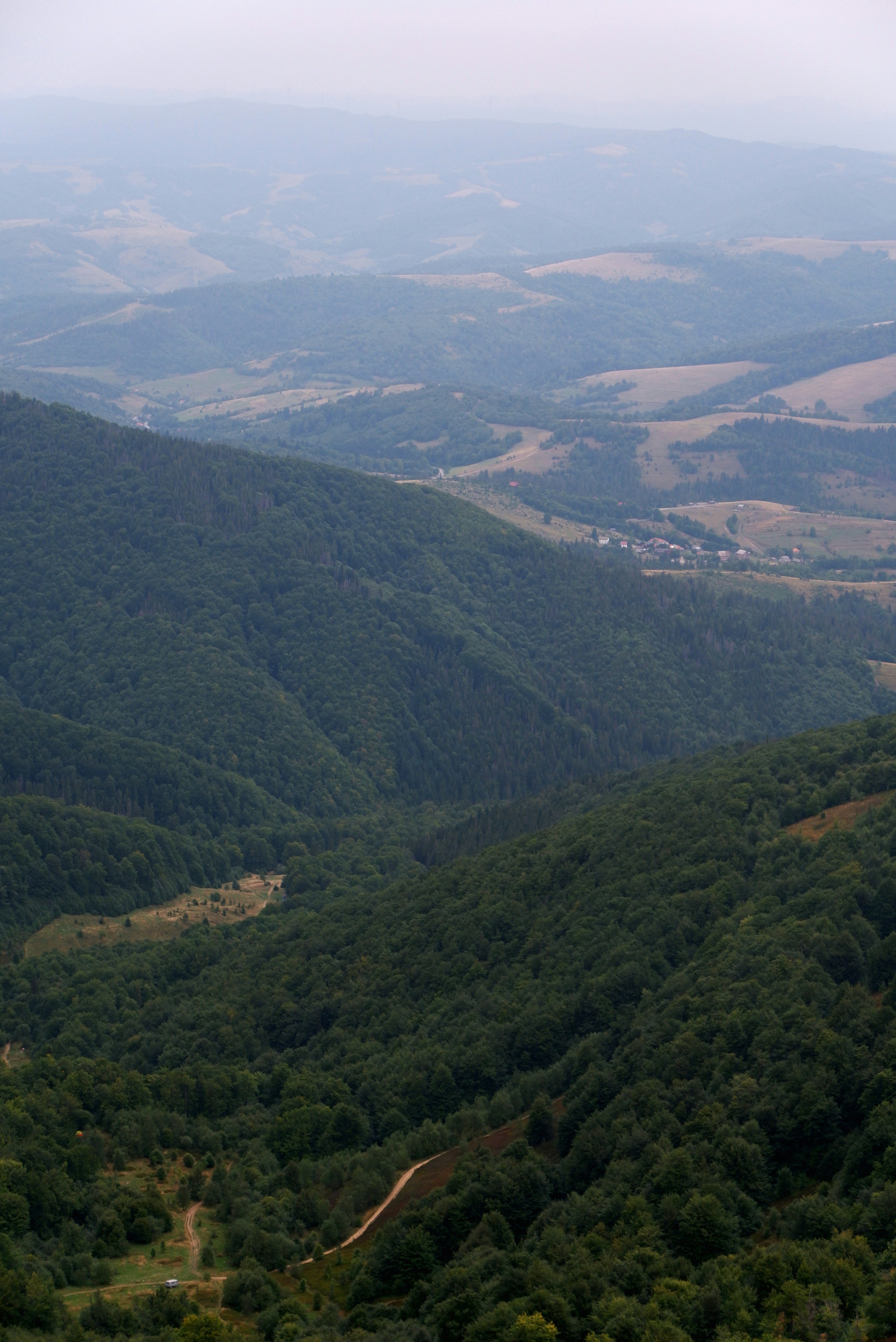 Mist over woven valleys: a valley panorama from the ridge