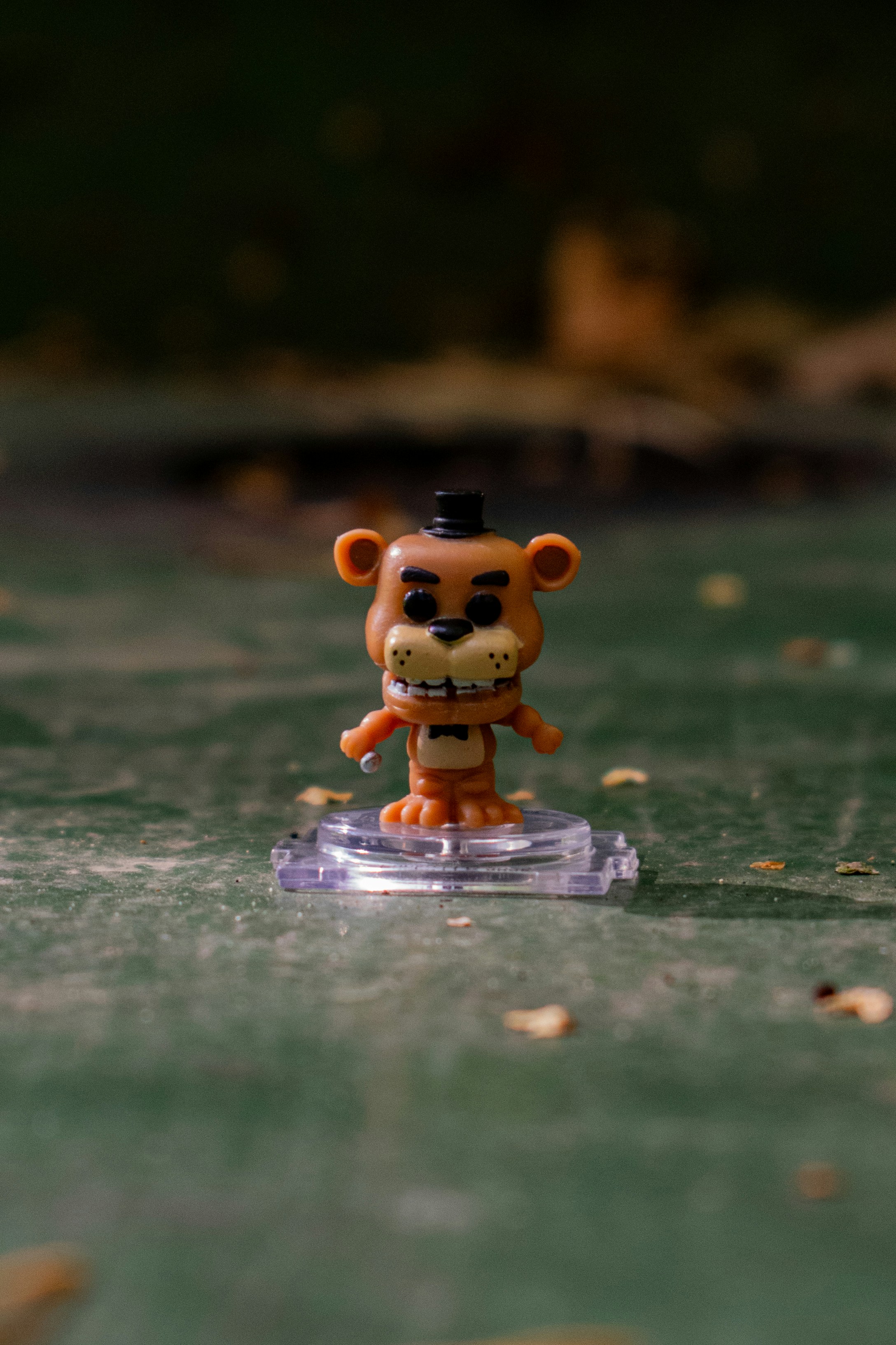 Tiny Exhibit: An Orange Plush Explorer Stands centerpiece on a blurred bench