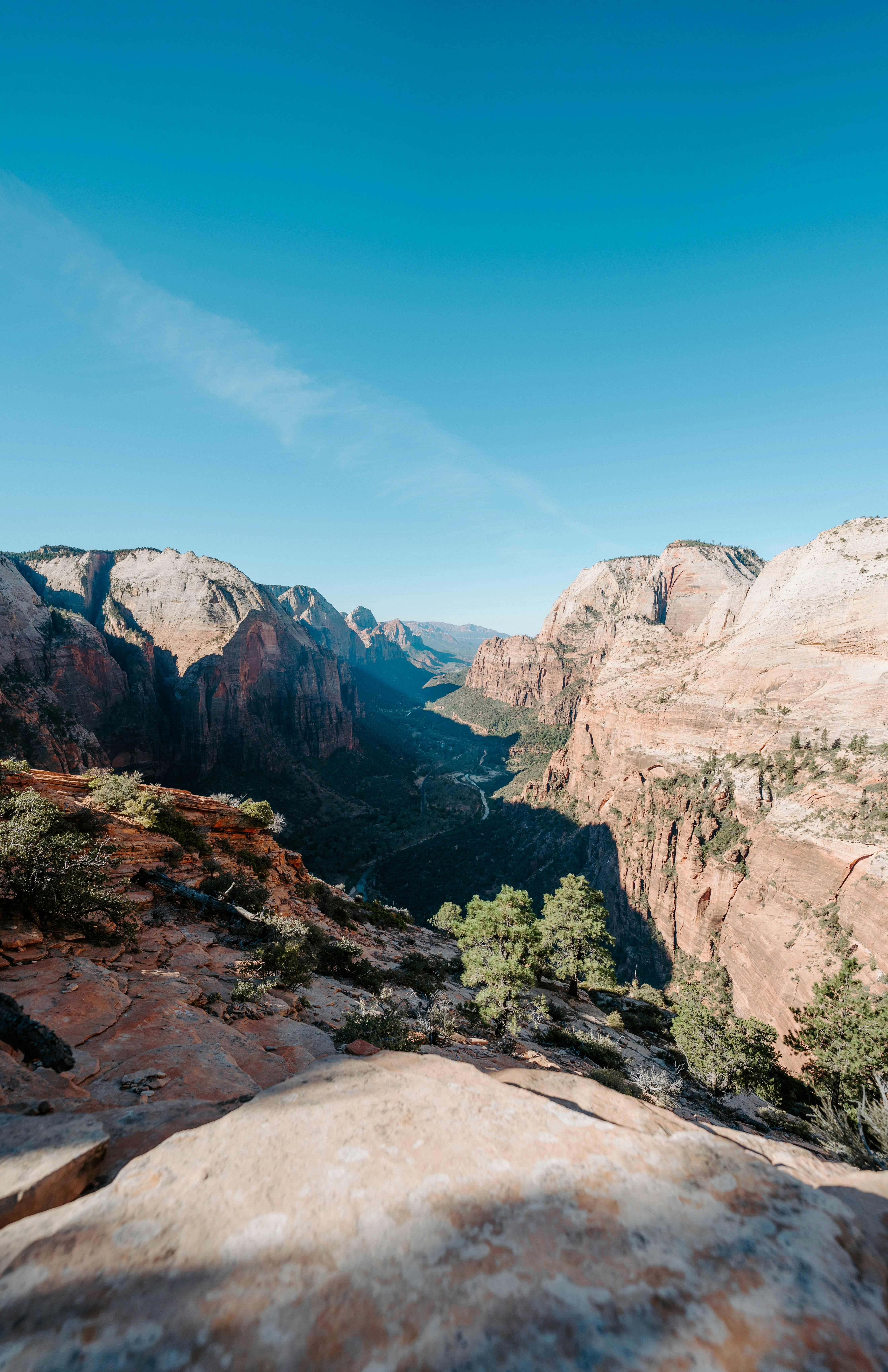 Vast Canyon Echoes: A Sunlit Rim Overlooking the Valley