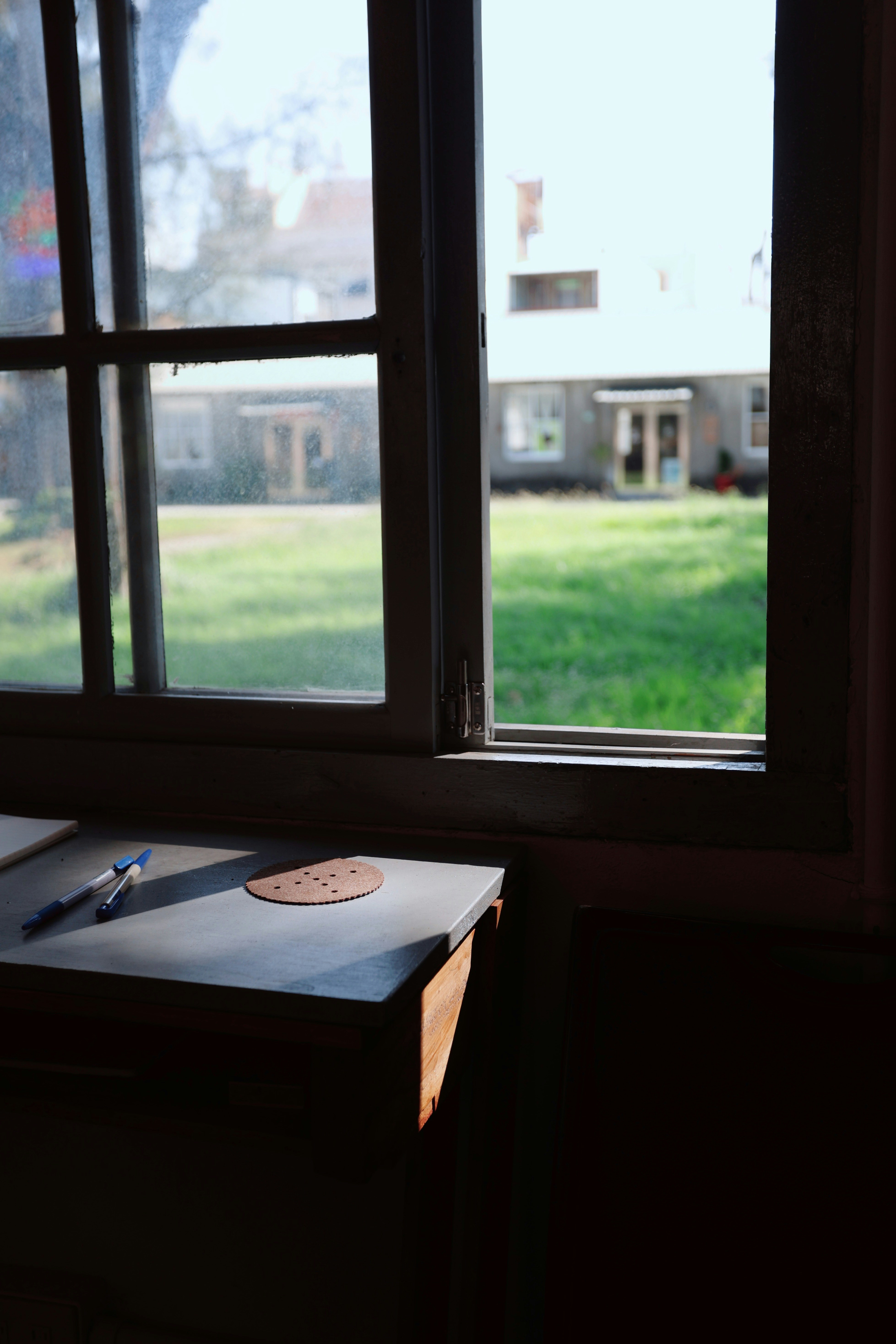 Sunlit Greenyard Through a Windowsill