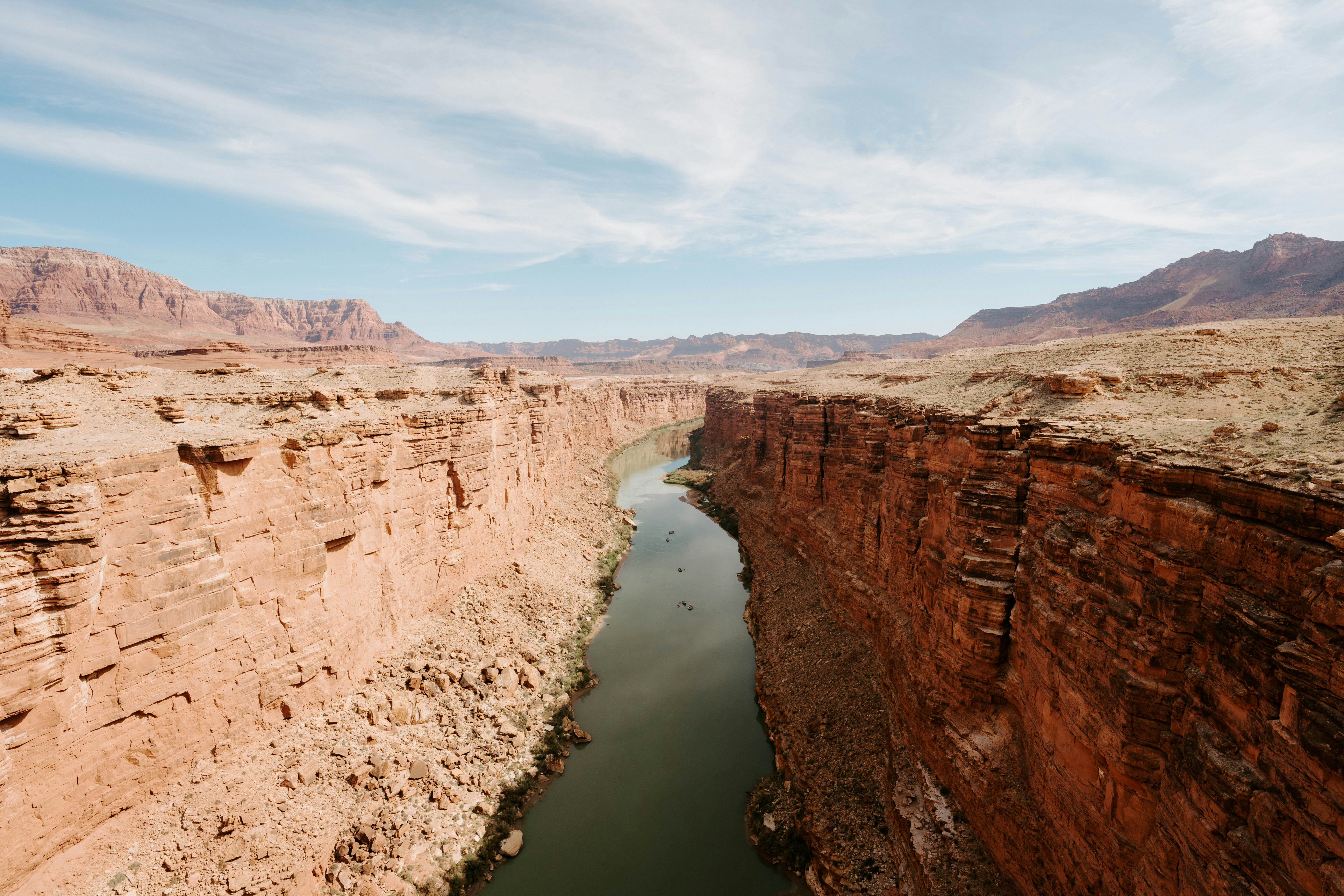 Rift in Redstone: A Narrow River Bends Between Canyon Walls