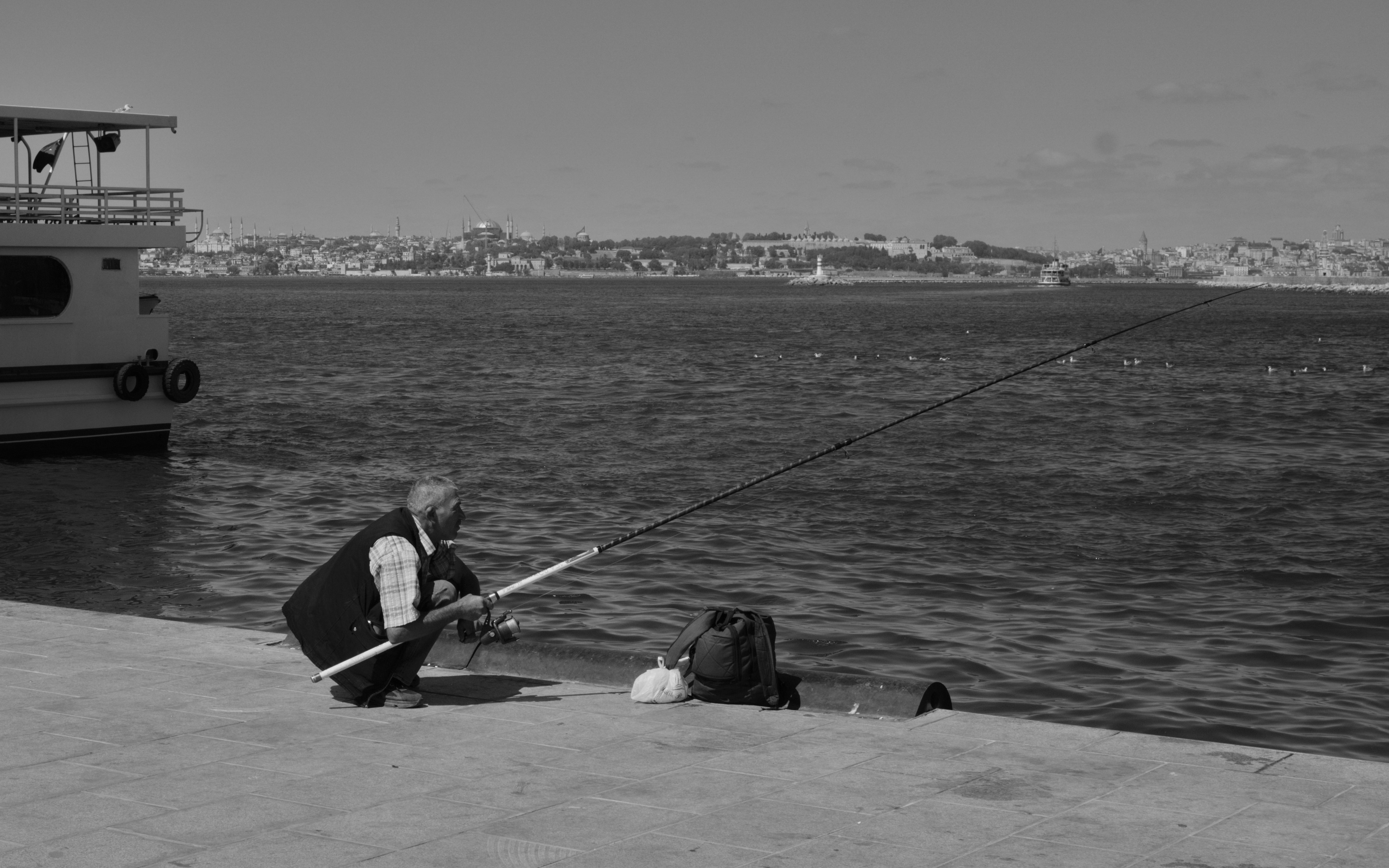 Line in Wait: A Fisherman’s Moment at Dusk