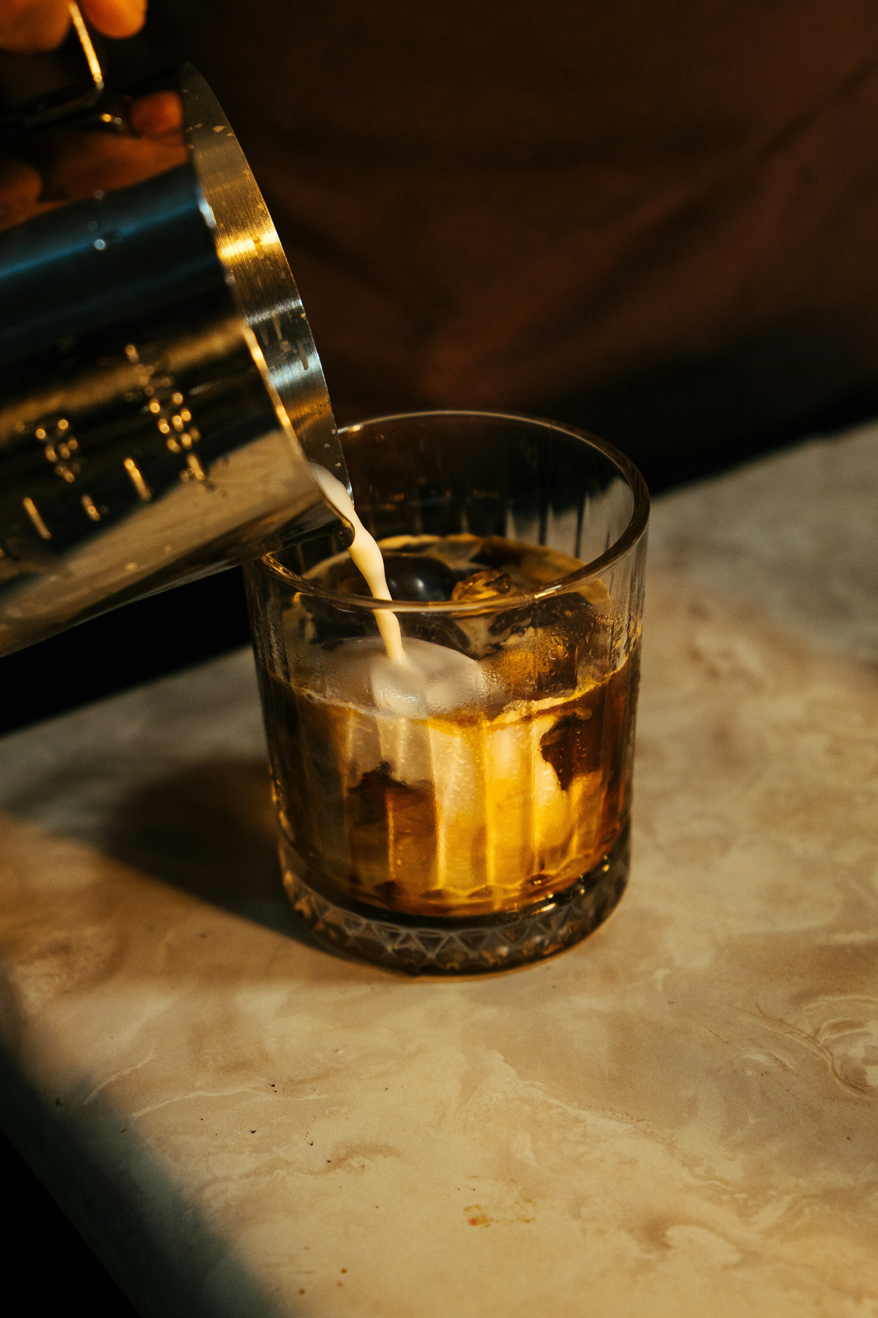 Pouring Cream into a Glass: A Quiet Moment at the Marble Bar