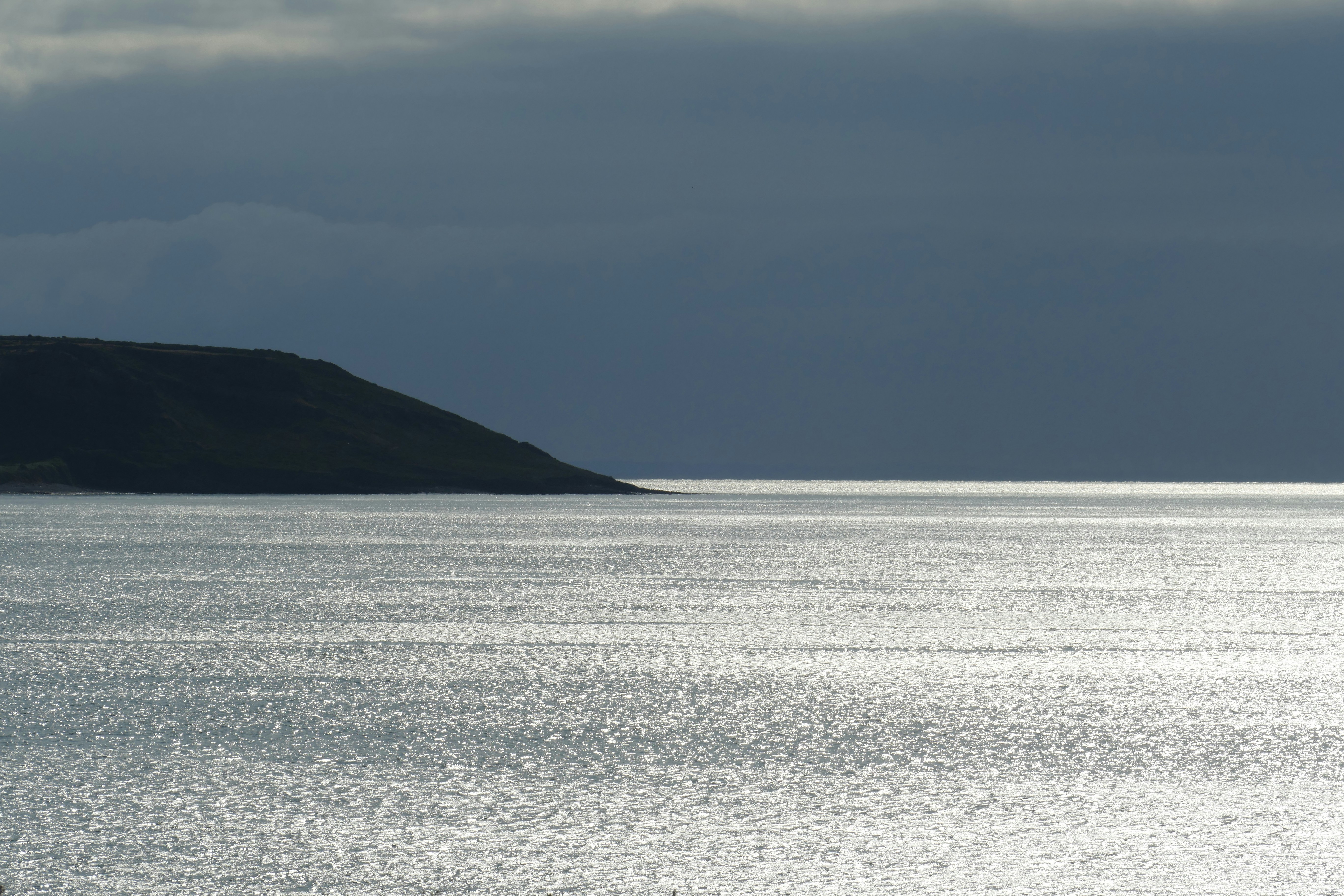 Silver Wake: Coastline Quiet Under Overcast Light