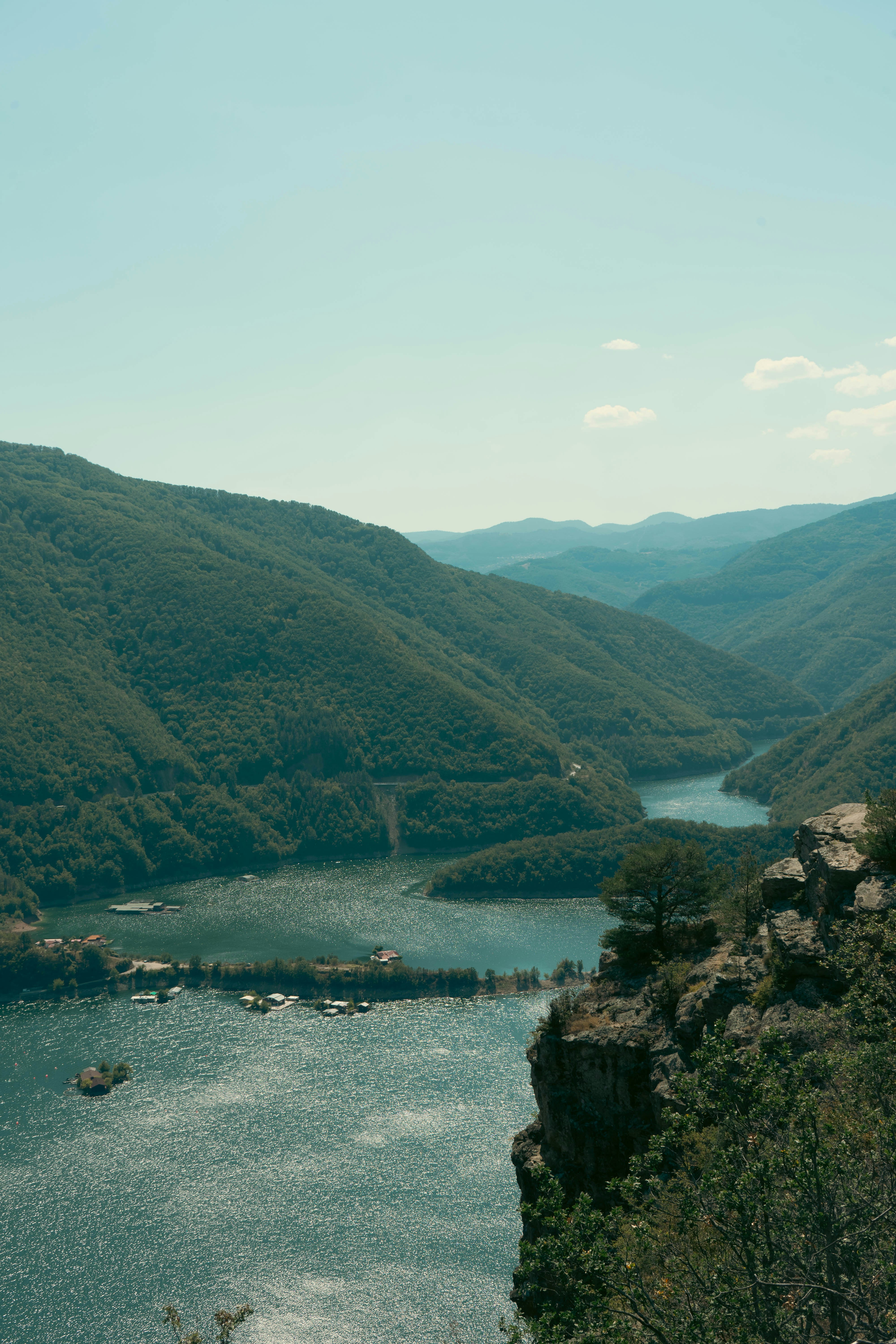 Valley Echoes: A River Winding Through Verdant Peaks