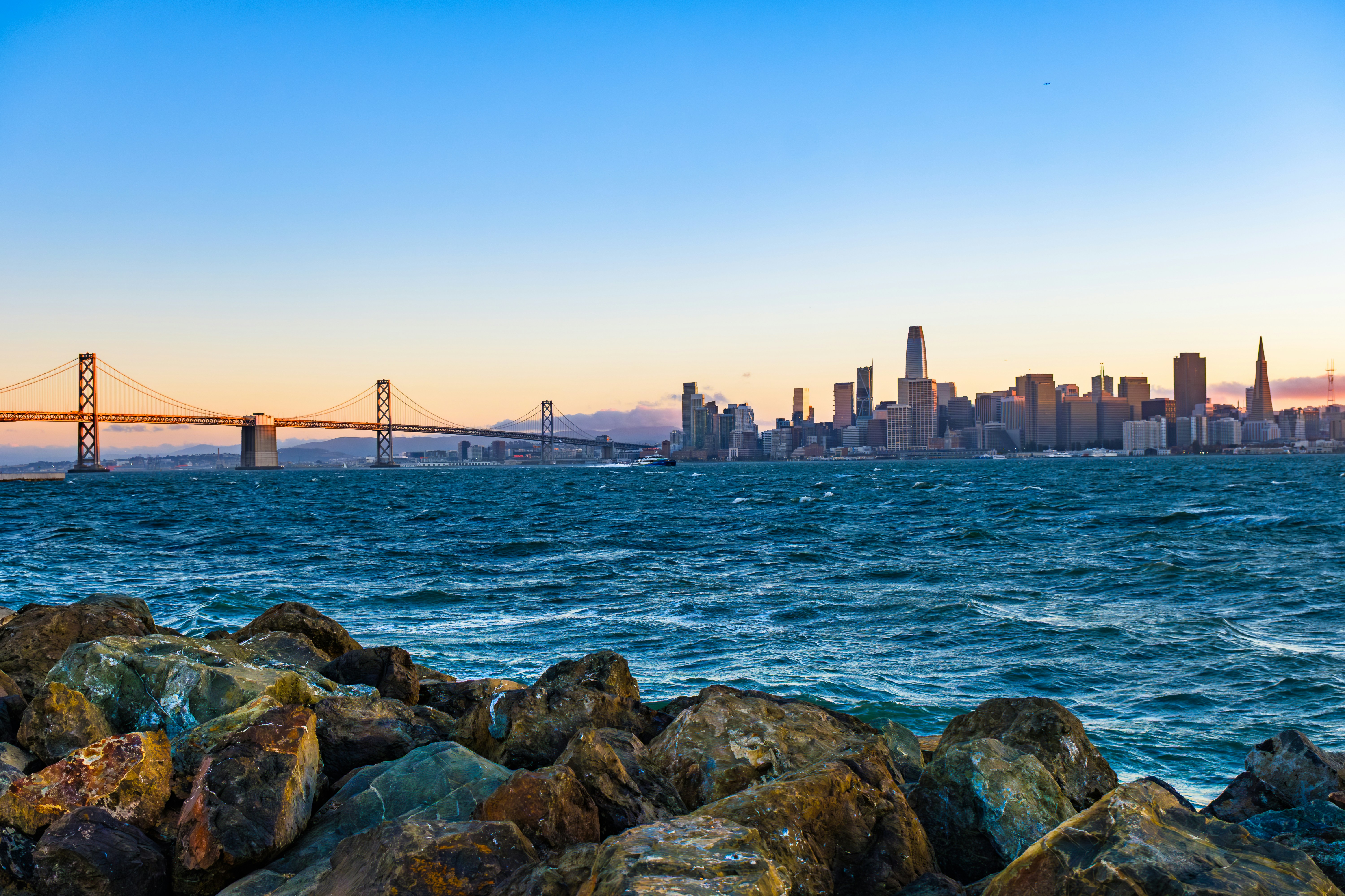 Bay Horizon: Golden Light Over Oakland Rocks and Skyline