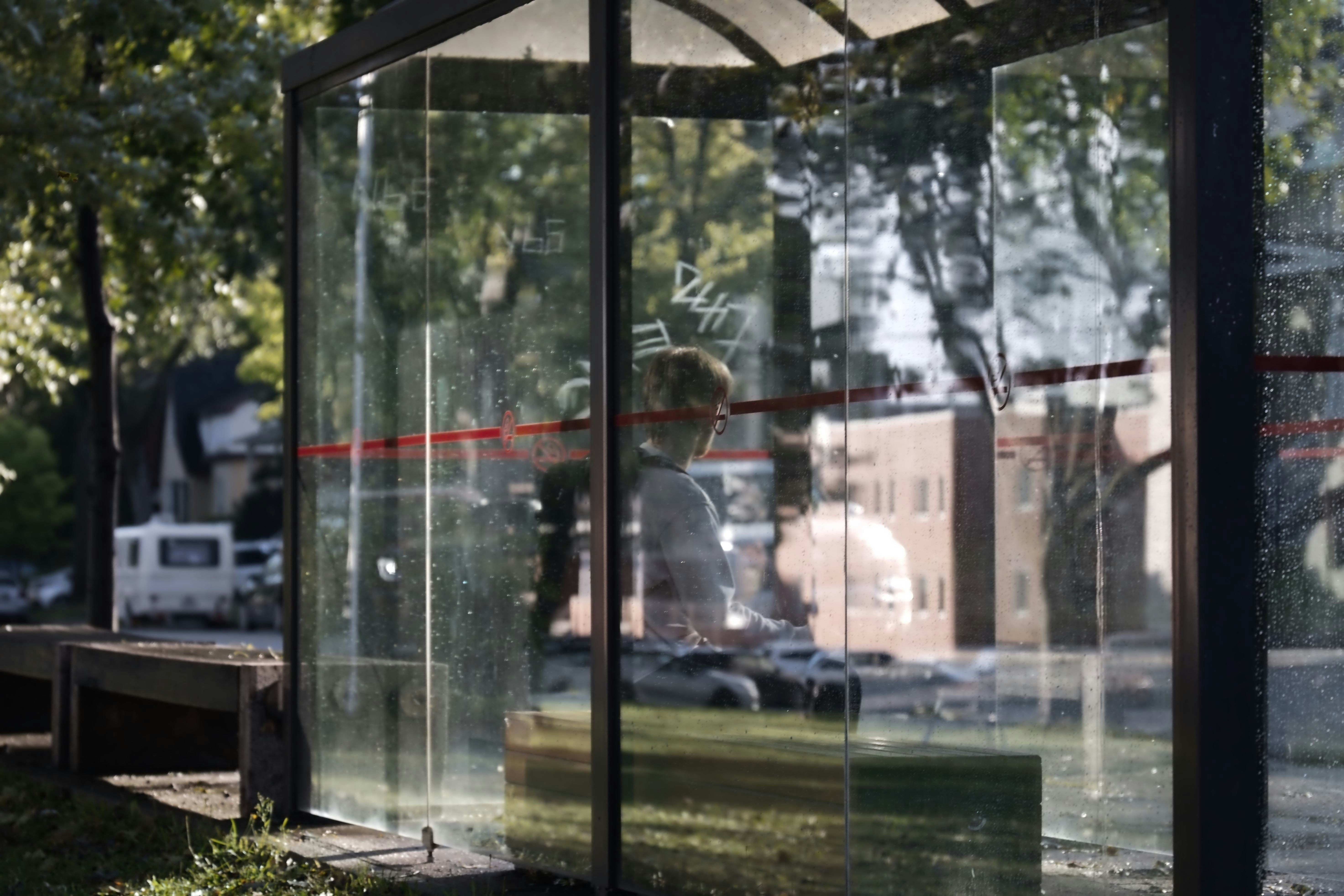 Glazed Bus Shelter: Quiet City Reflection Through Glass