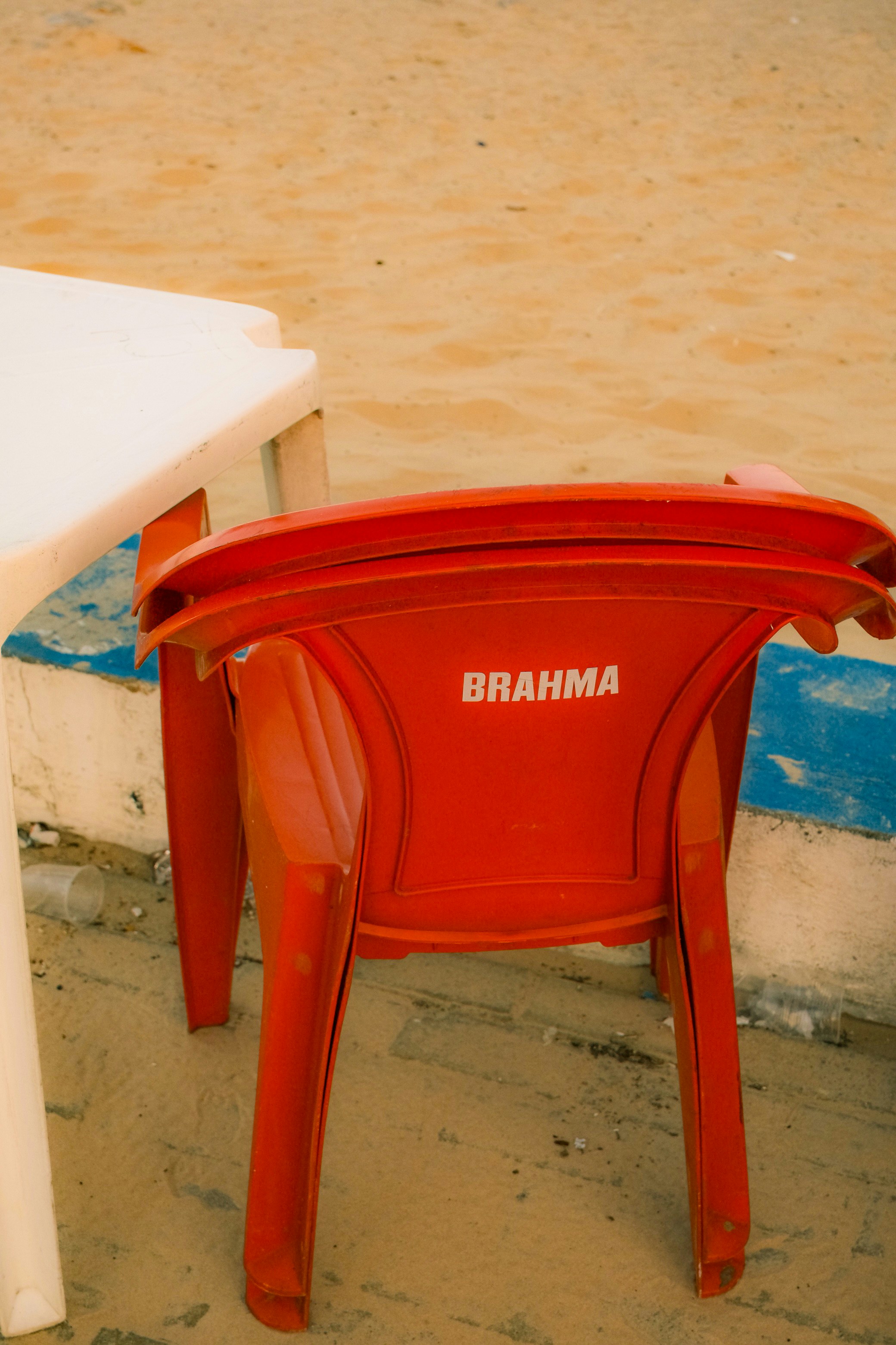 Red Plastic Chair with Brahma Branding at Sunset Beach