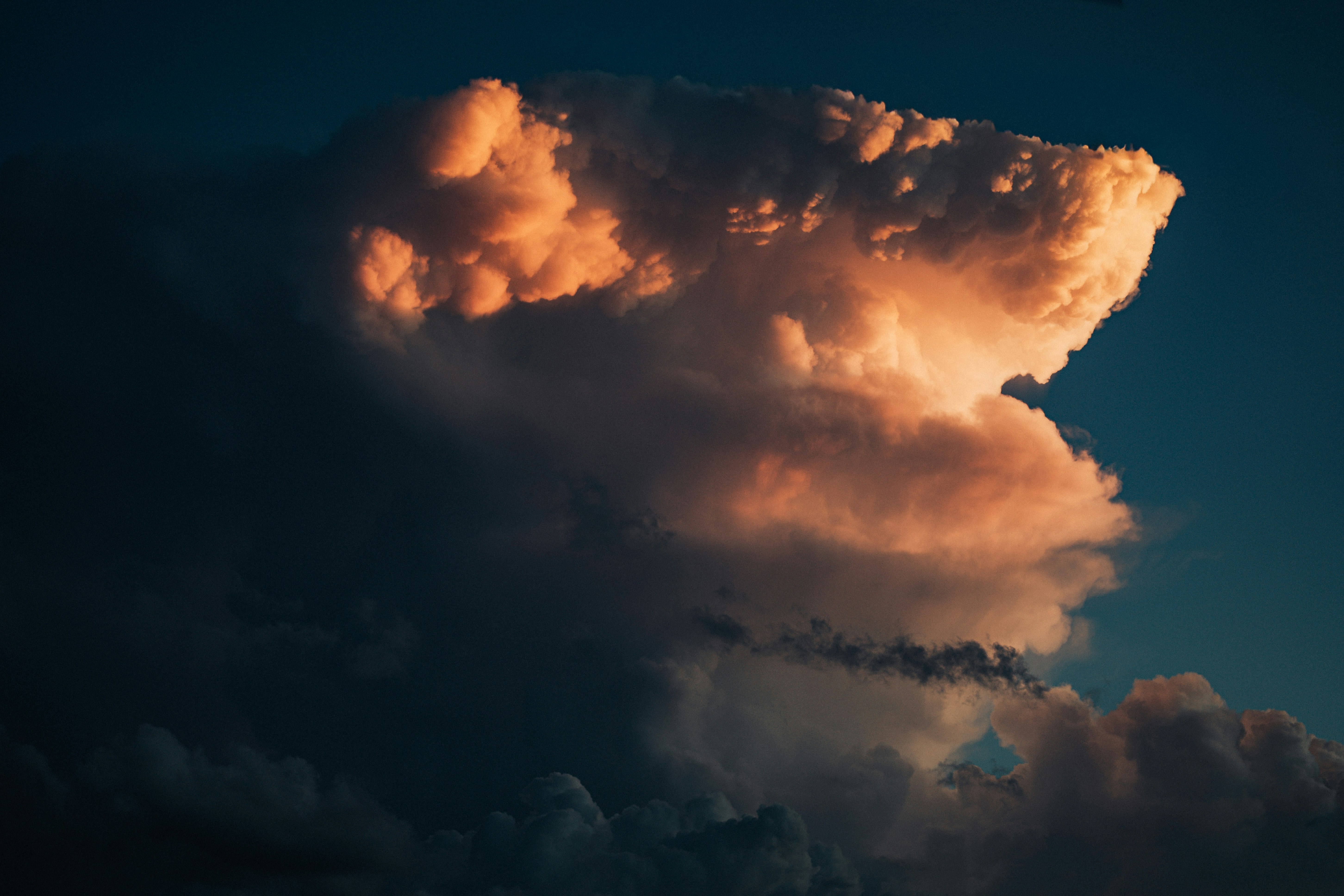 Emergence in the Cloud: Sunlit Crest Among Dark Majesties