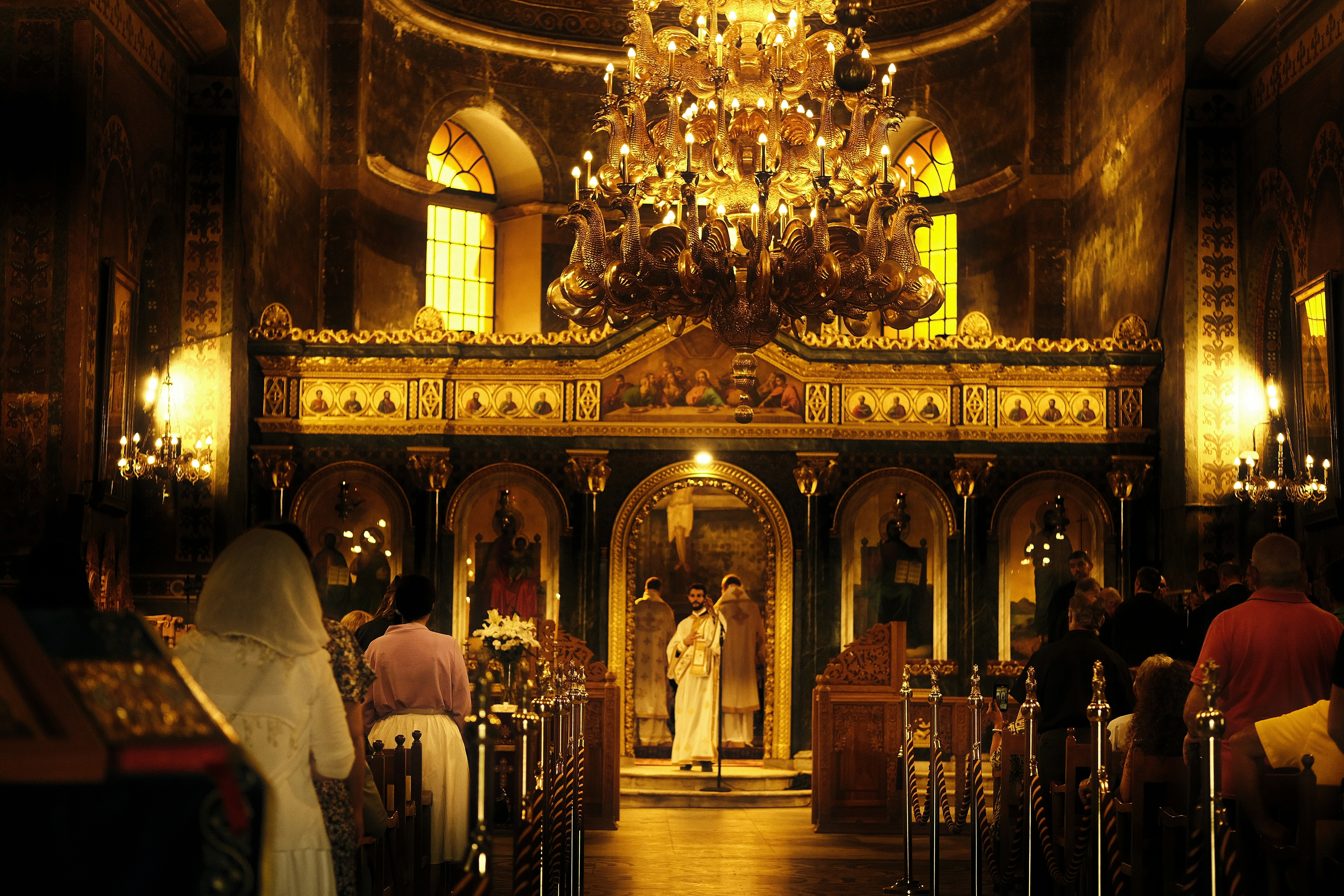 Golden Halo: A Solemn Rite Within an Ornate Church Interior