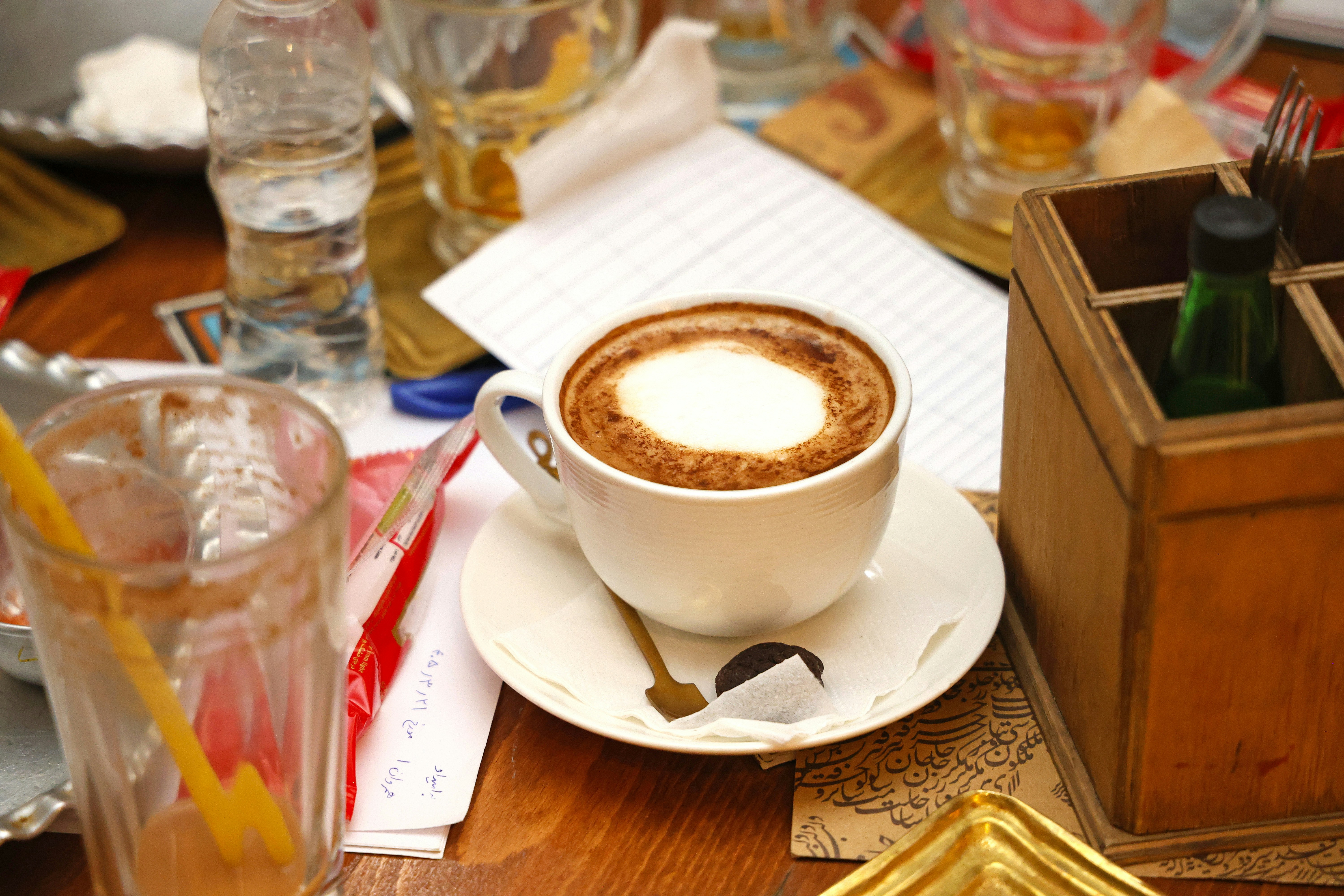 Creamy centerpiece: a cappuccino savoring the café clutter
