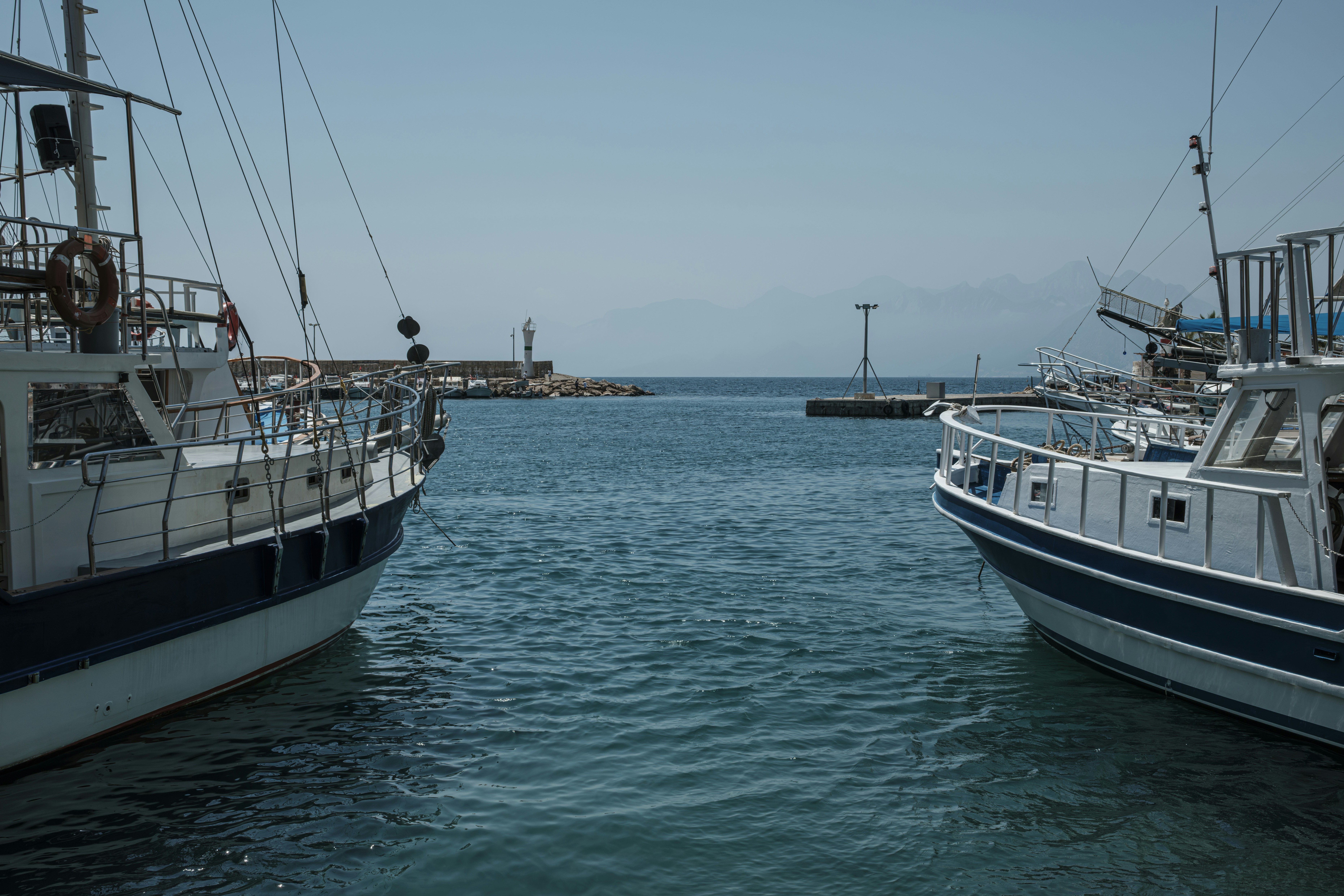 Harbor Threshold: Boats Framing a Quiet Sea