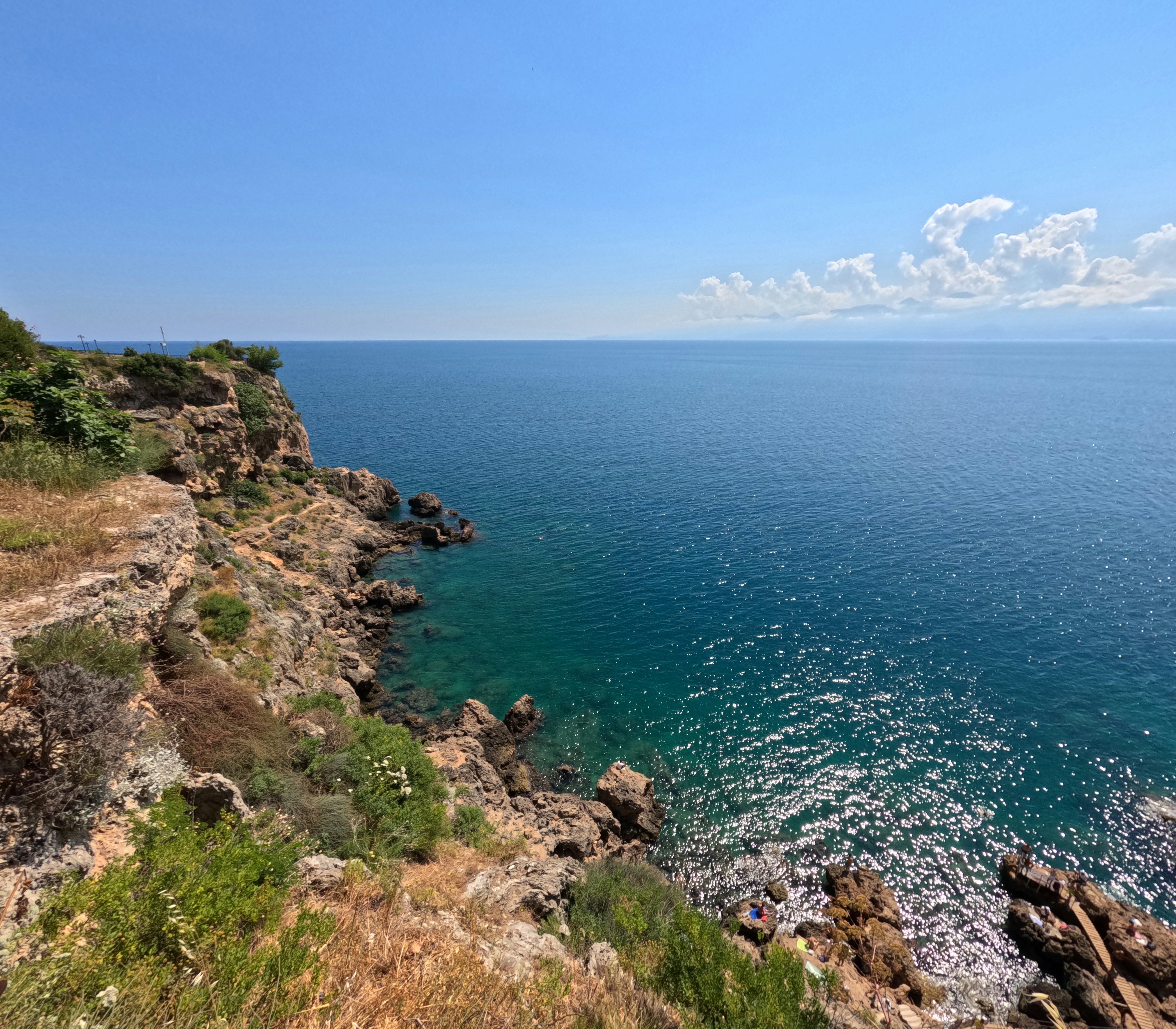 Cliff Edge Over Ocean: Sunlit Aegean Crest