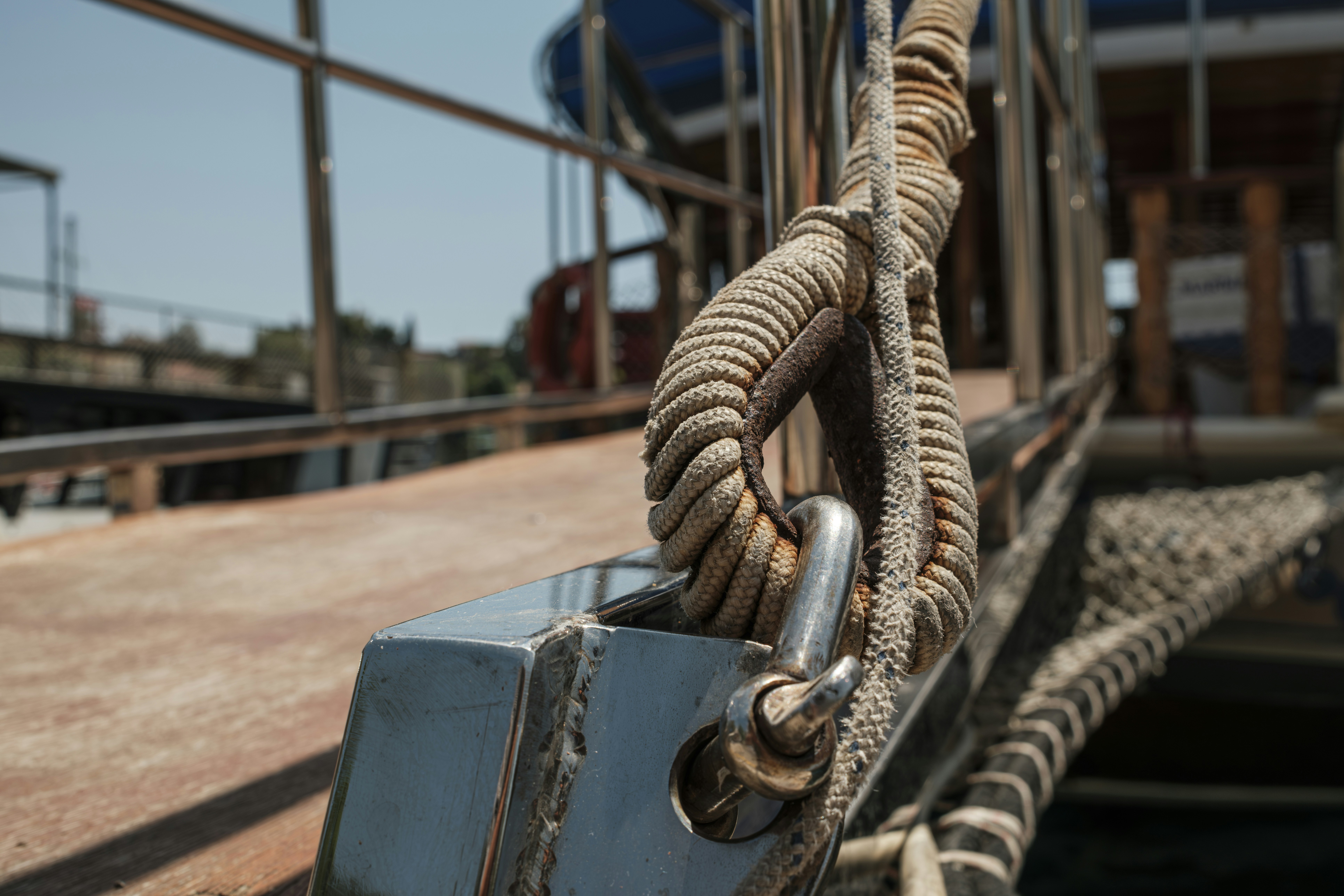 Tethered Rope and Metalwork: Coastal Dock in Quiet Focus