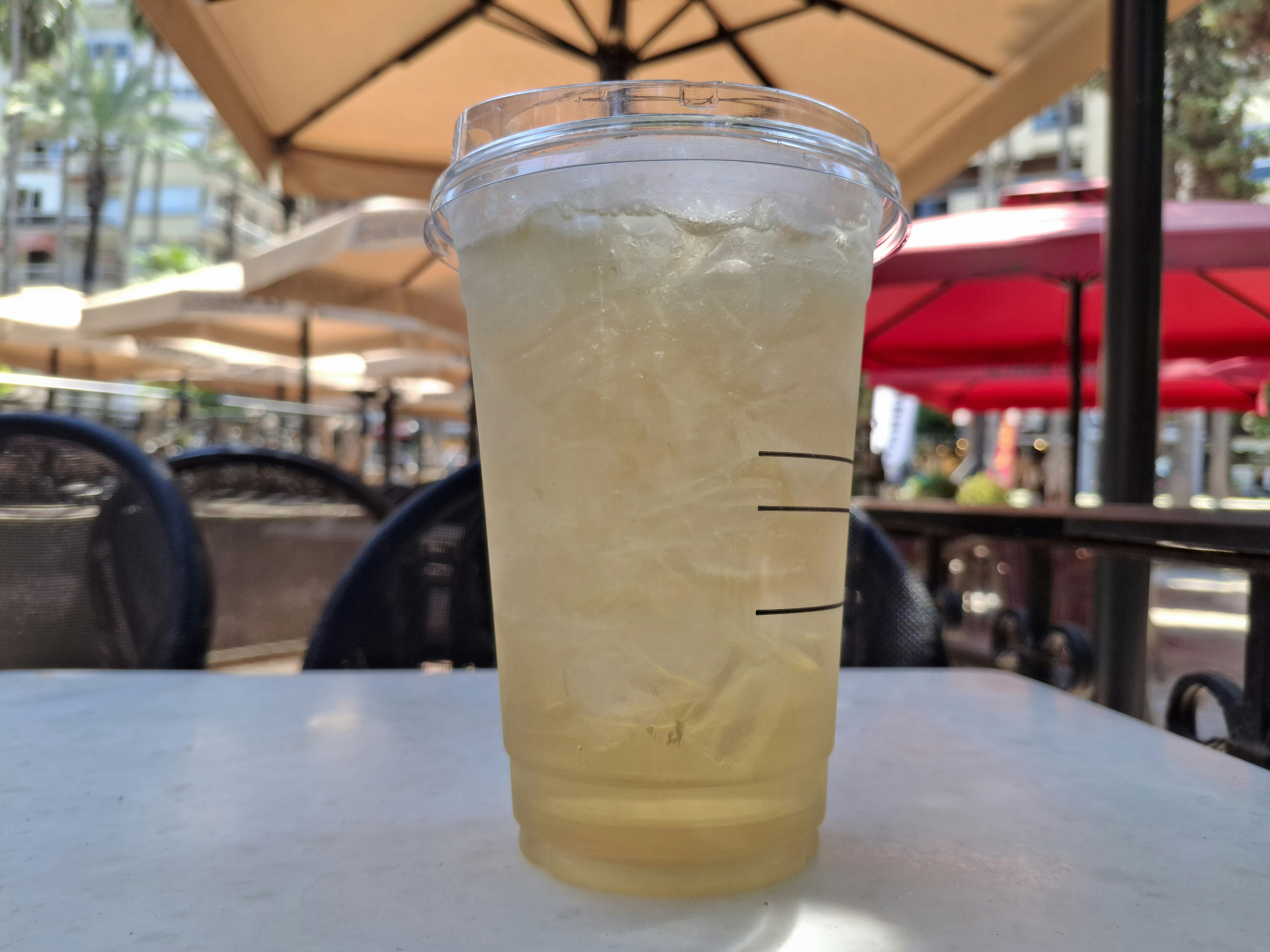 Iced Beverage with Outdoor Café Backdrop