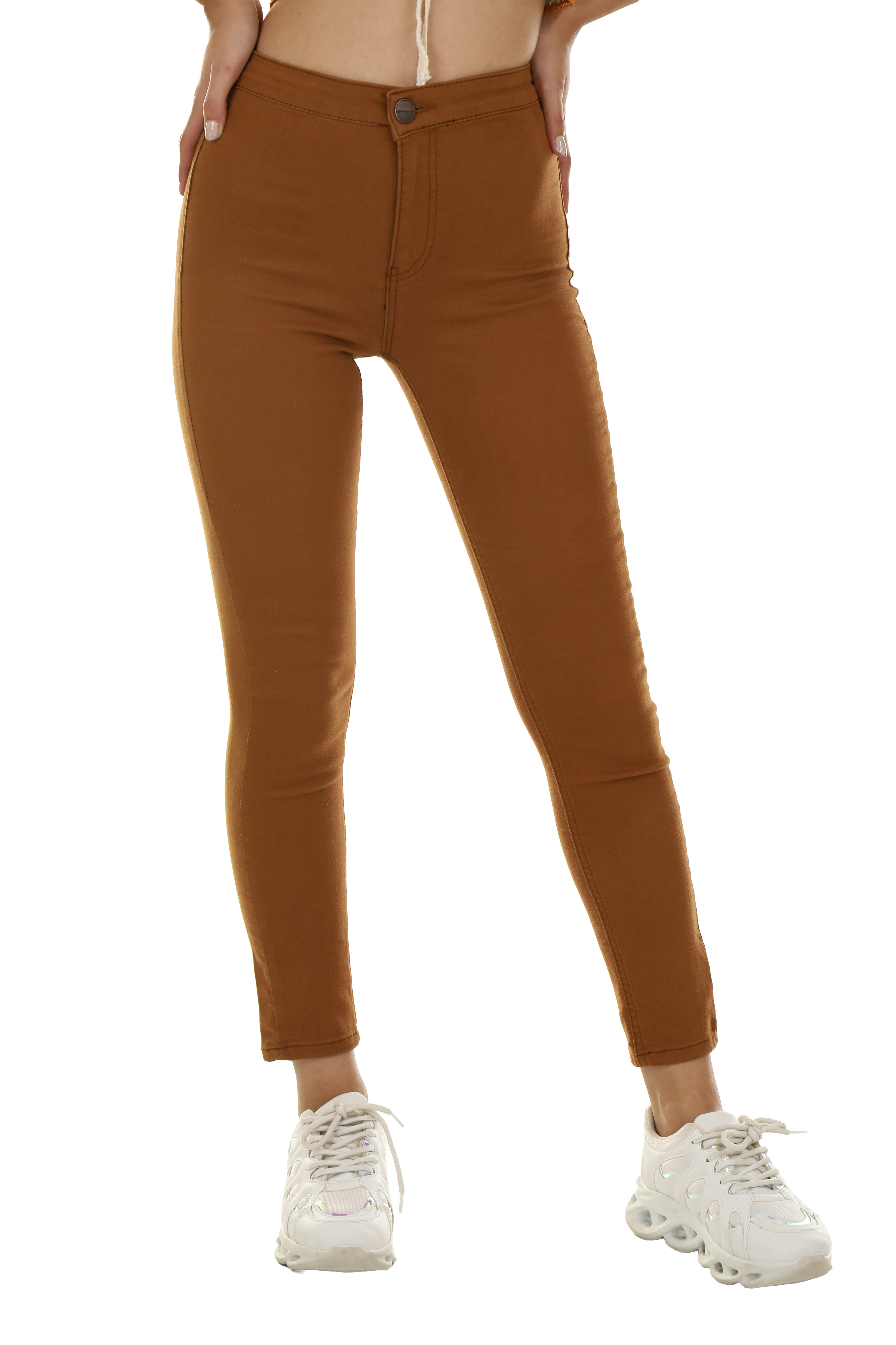 Grounded in Cocoa: cropped midsection of rust-brown jeans and sneakers