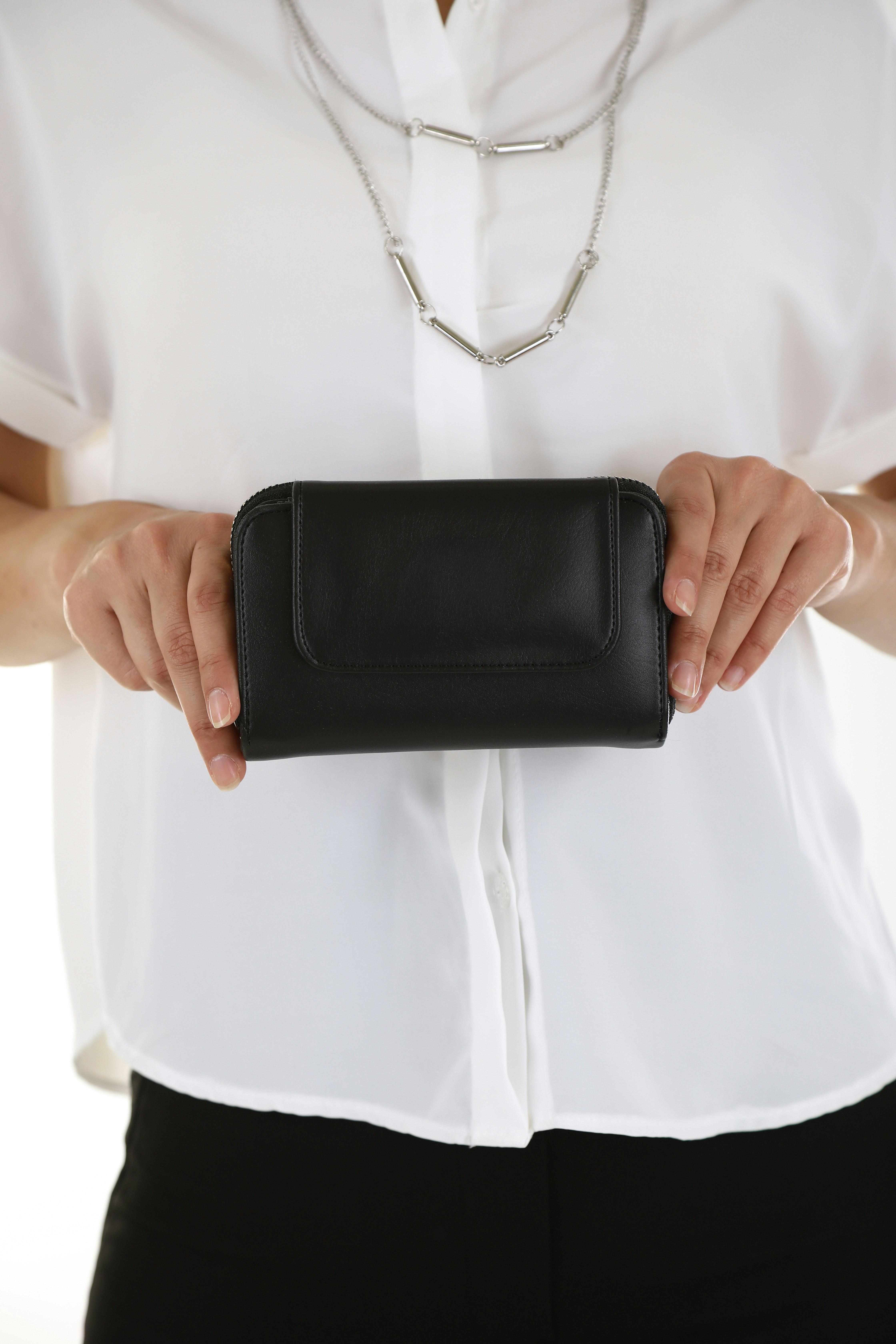 Hands Full: A Black Leather Wallet Grasped Between Two Fingers