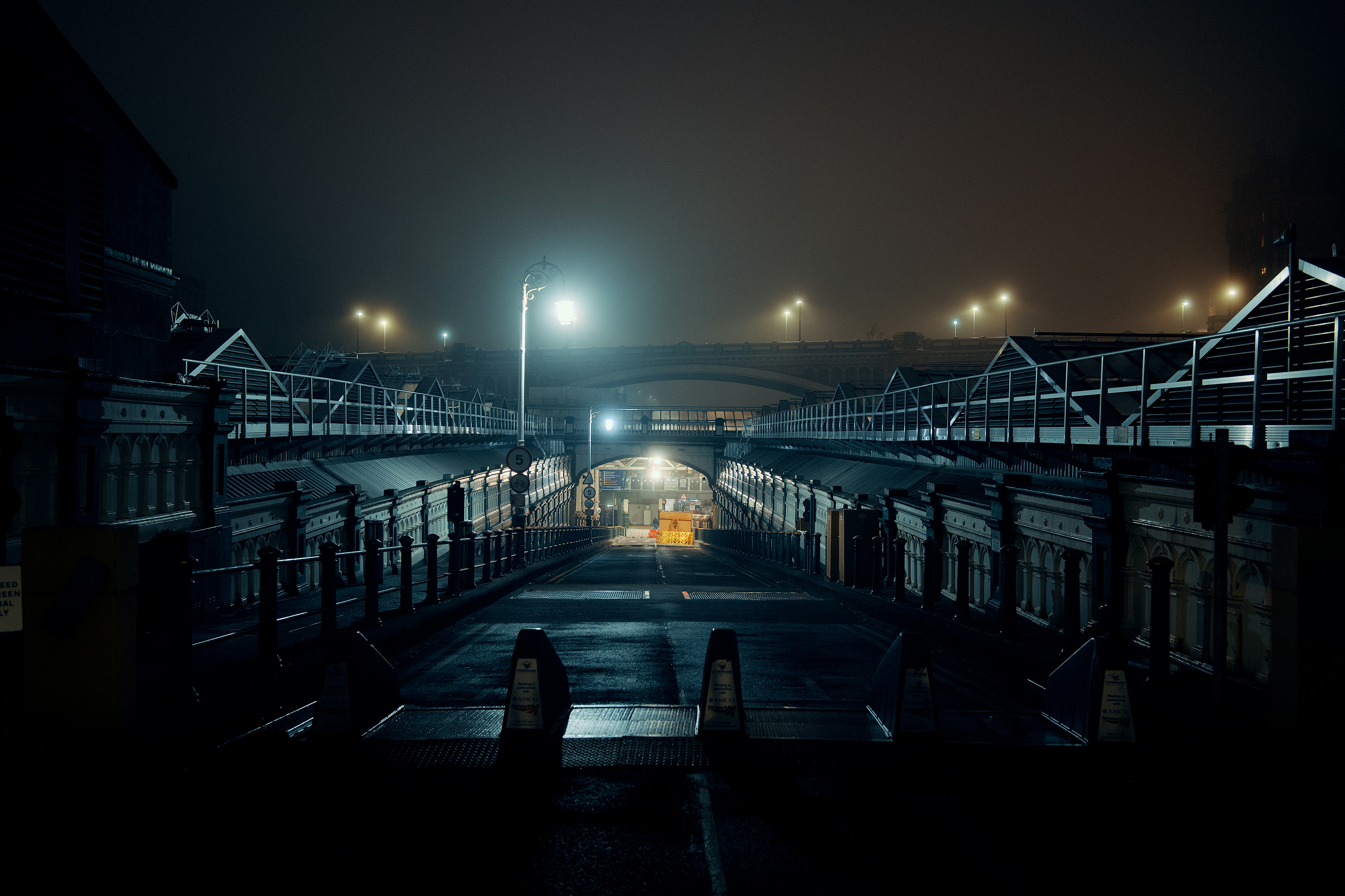 Under Neon Rails: Nighttime Pier Approach Toward the Lantern Gate