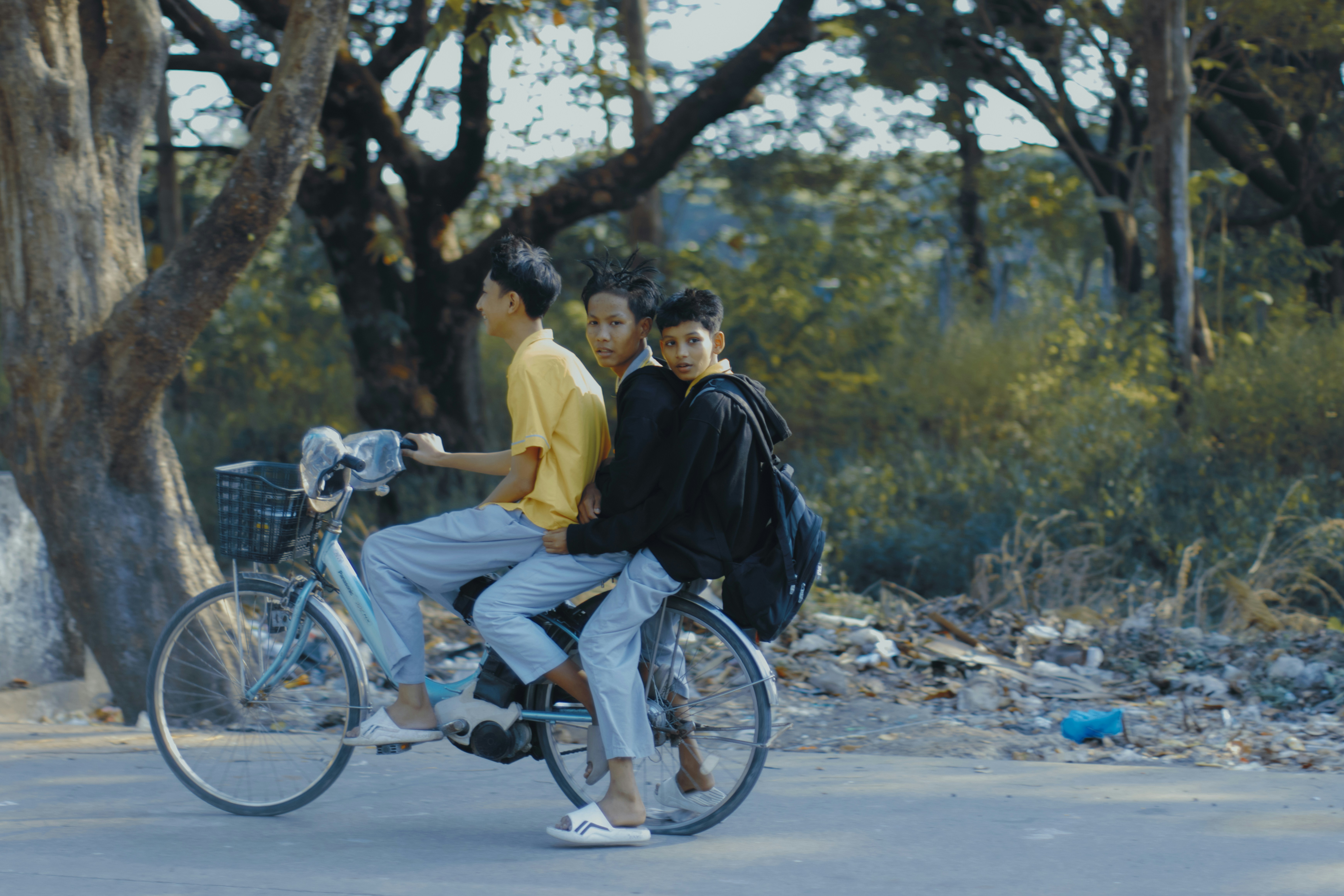 Three on a Bicycle: A Quiet Moment in the Park