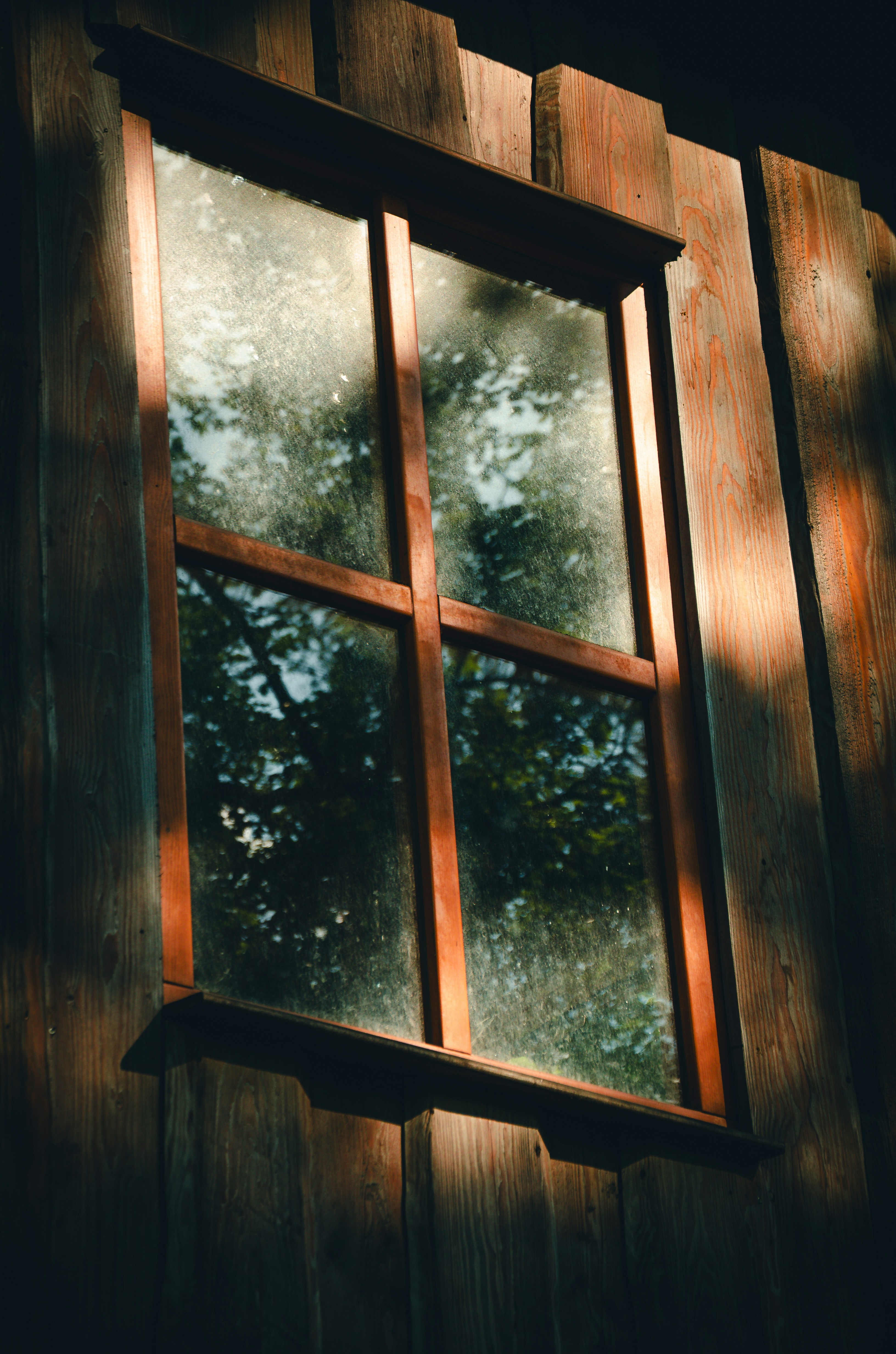 Sunlit Window Framed in Weathered Wood