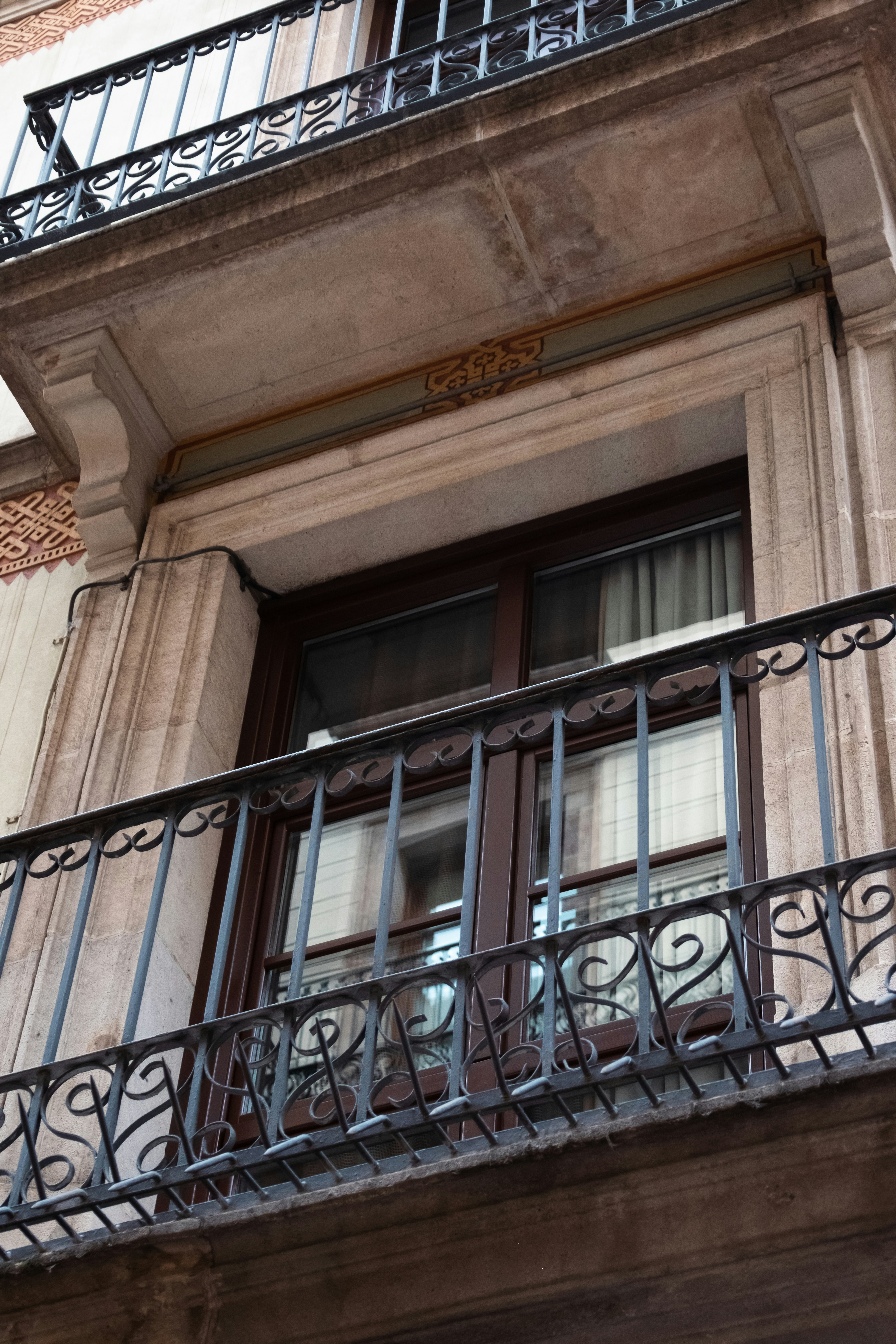 Balcony Grilles and Stone Frieze on a Madrid-Style Facade