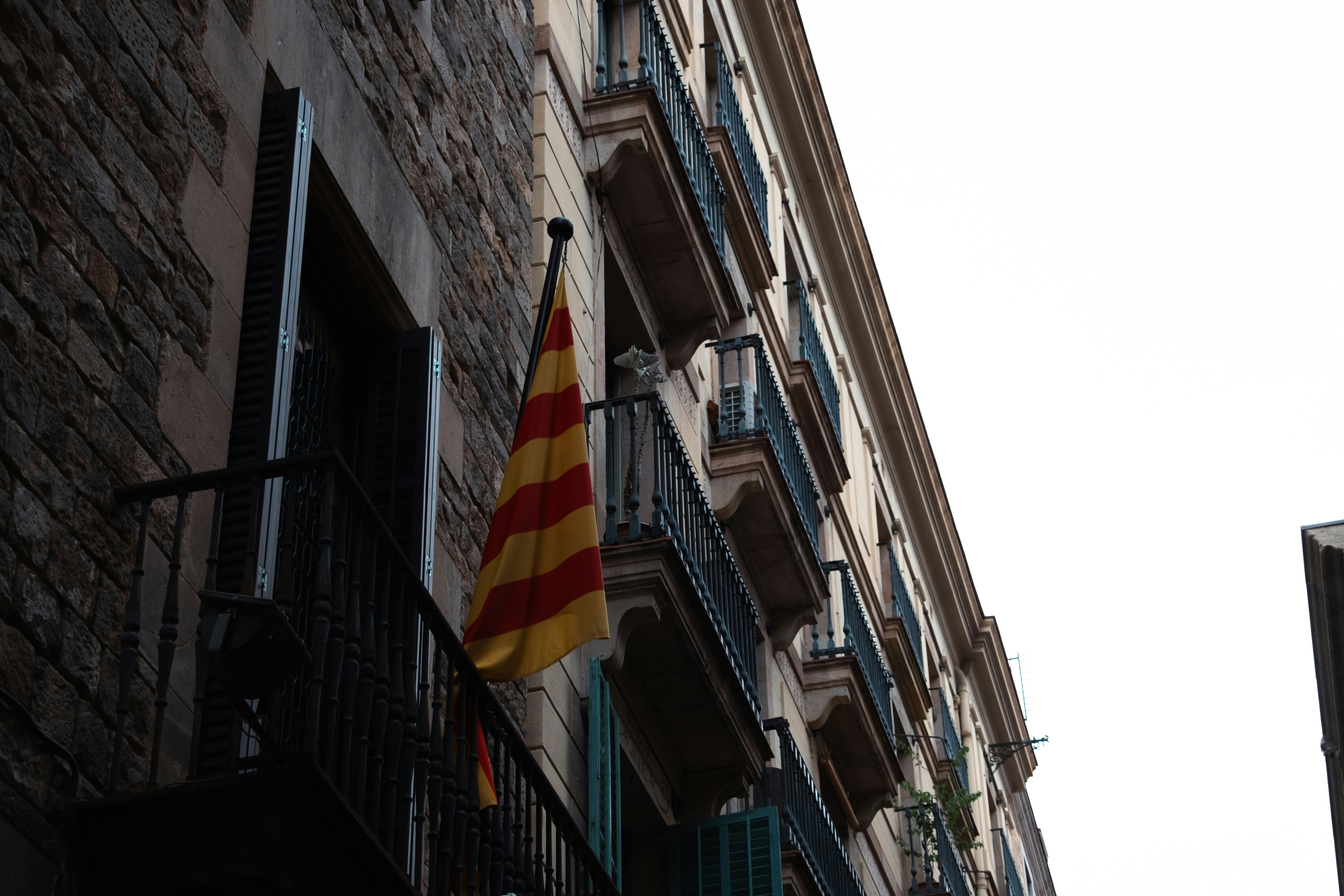 Flag on a Balcony Framed by Historic Facades