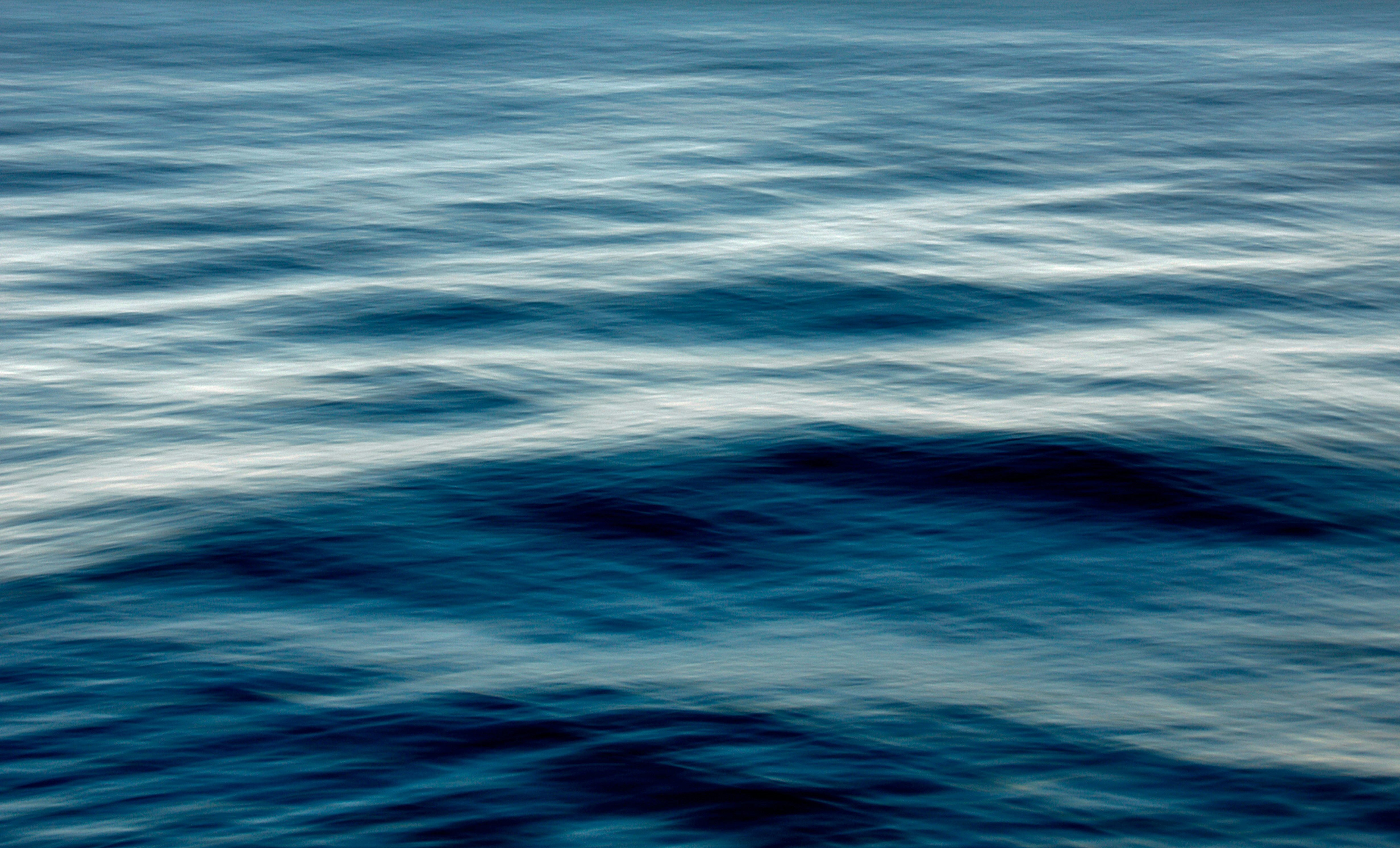 Waves in Quiet Motion over Deep Blue Evening
