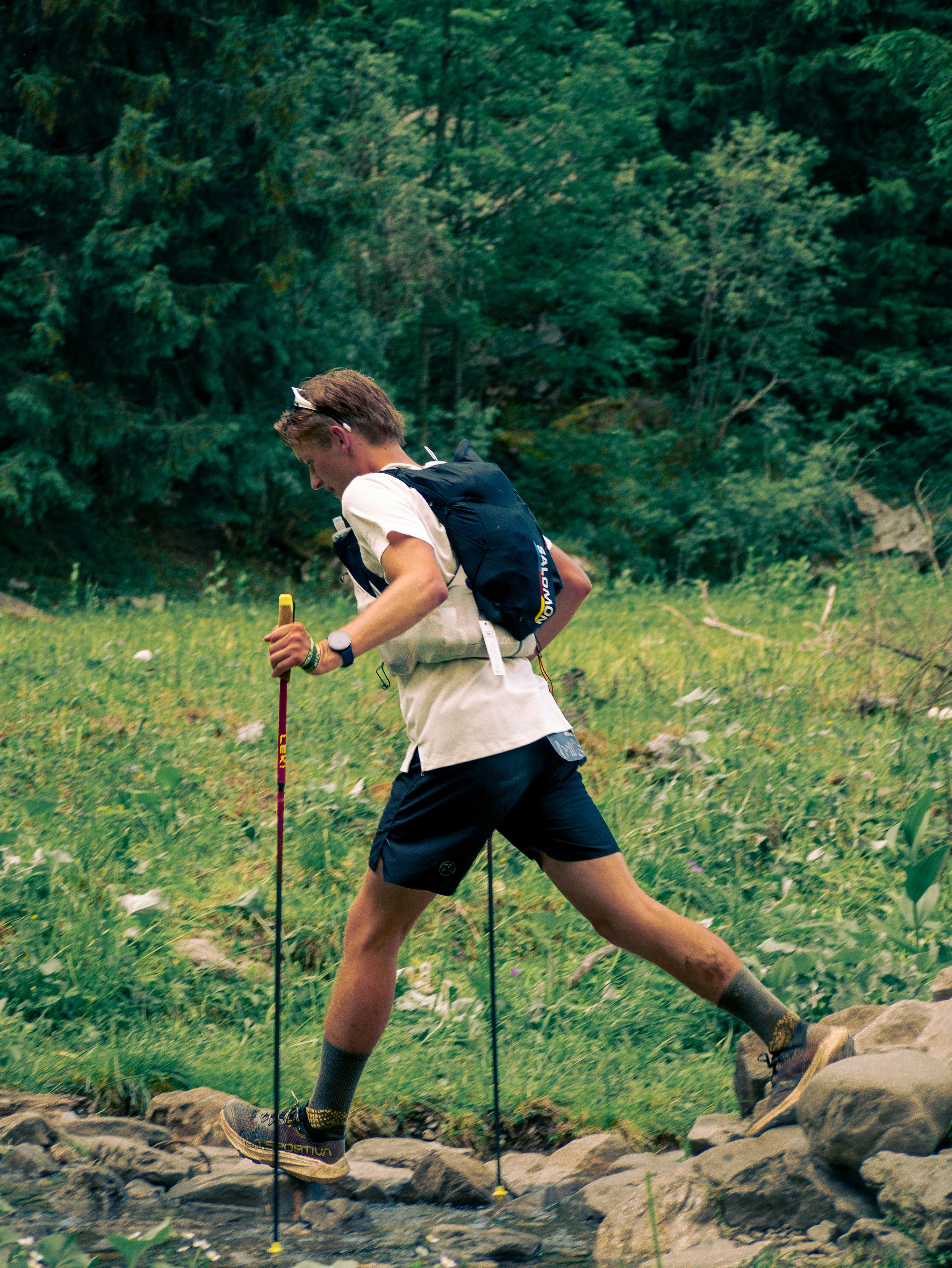 Trailbound: A Backcountry Trekker Navigates a Pebble-Strewn Stream