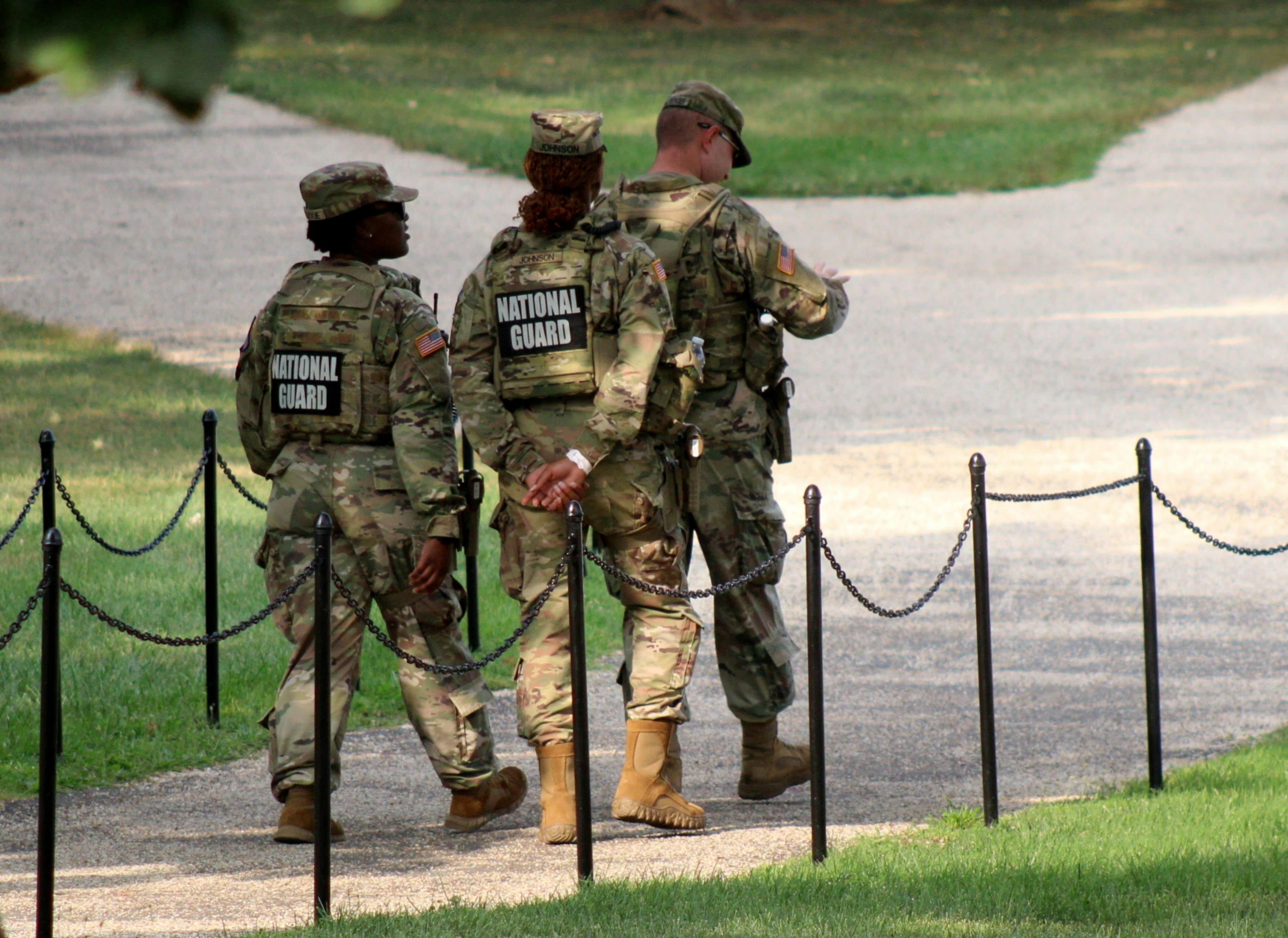 Three Soldiers in Quiet Convergence at a Chain-Guarded Path