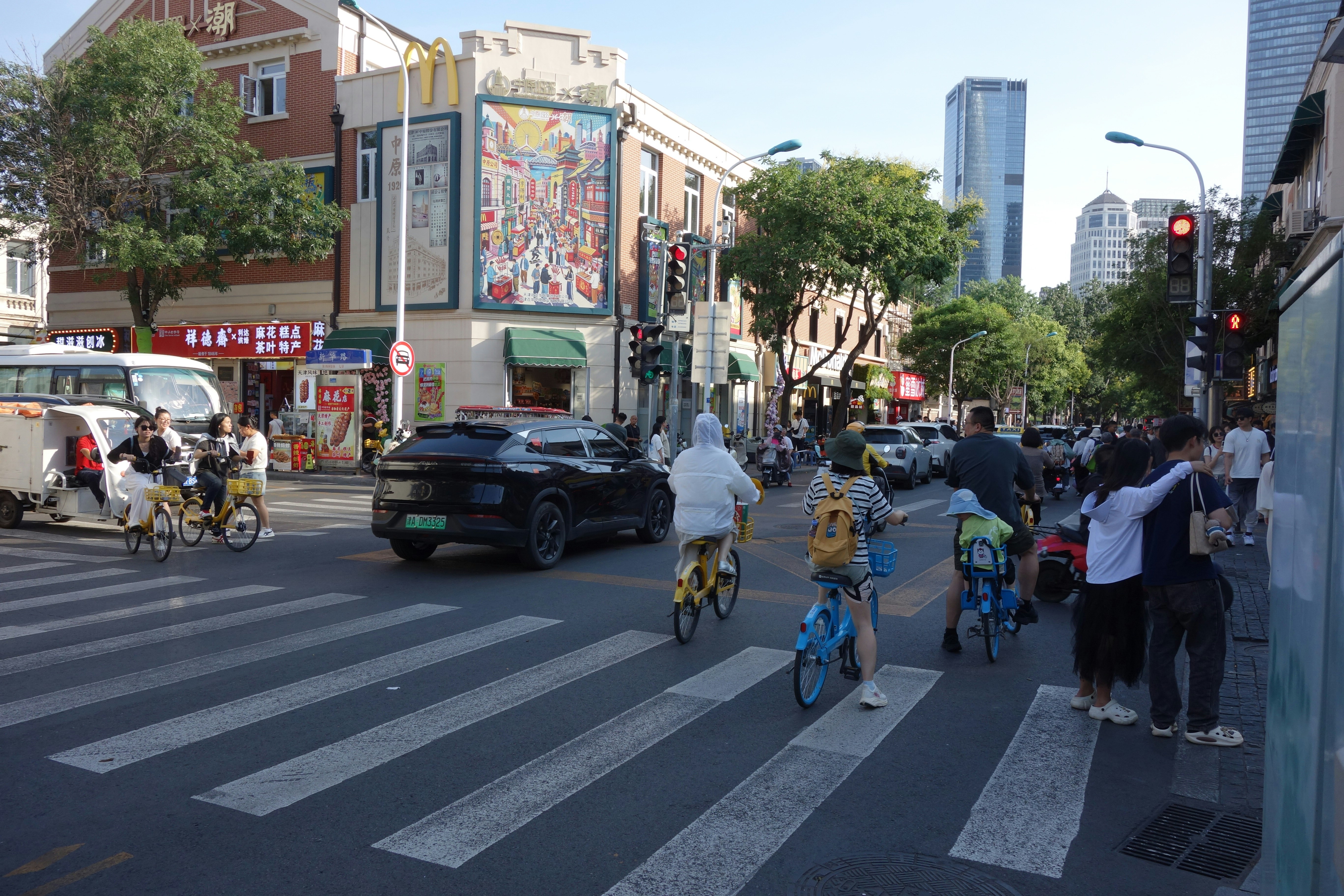 Crosswalk Pulse: Street Scene with Cyclists and Pedestrians