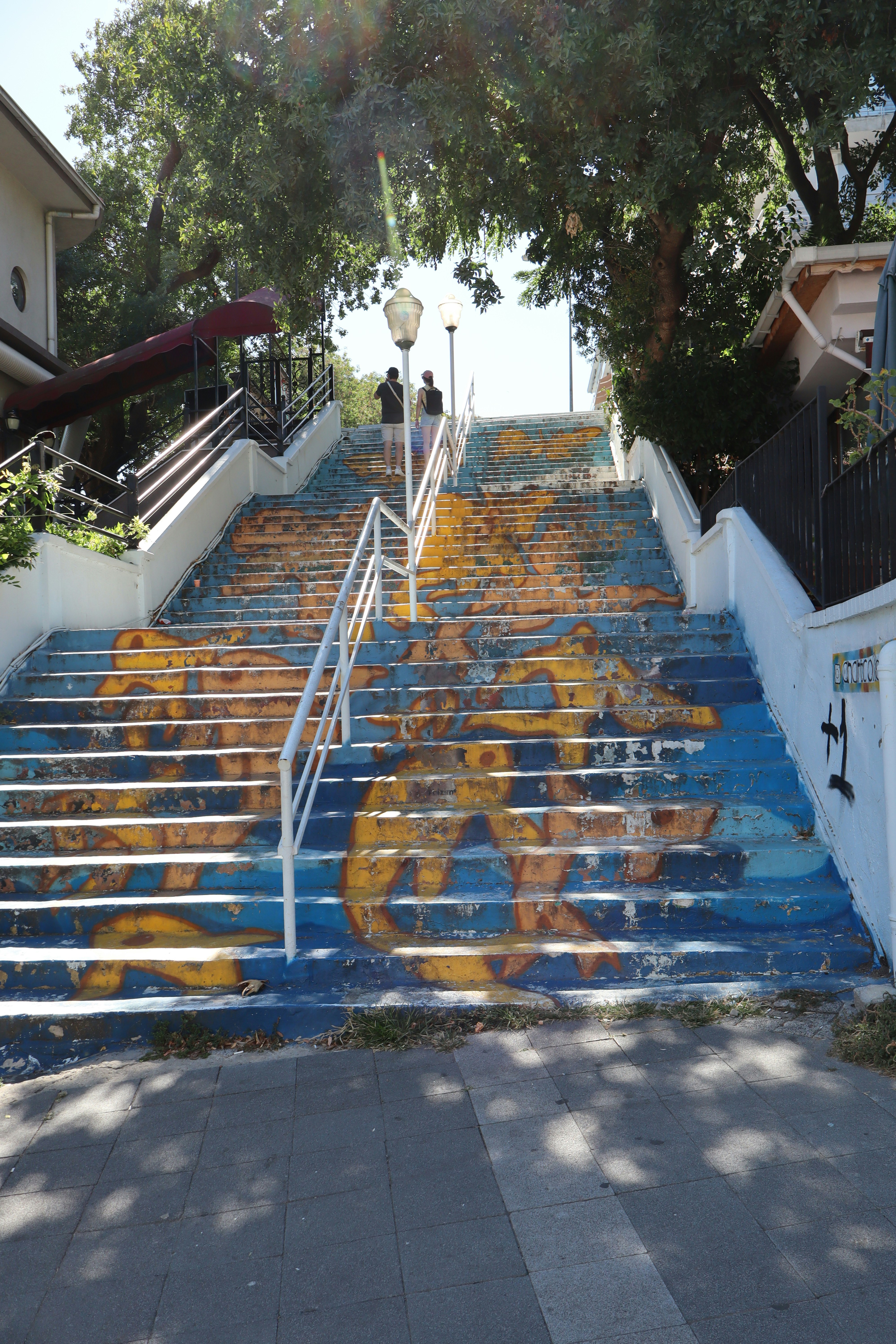 Graffitied staircase to lighted plaza