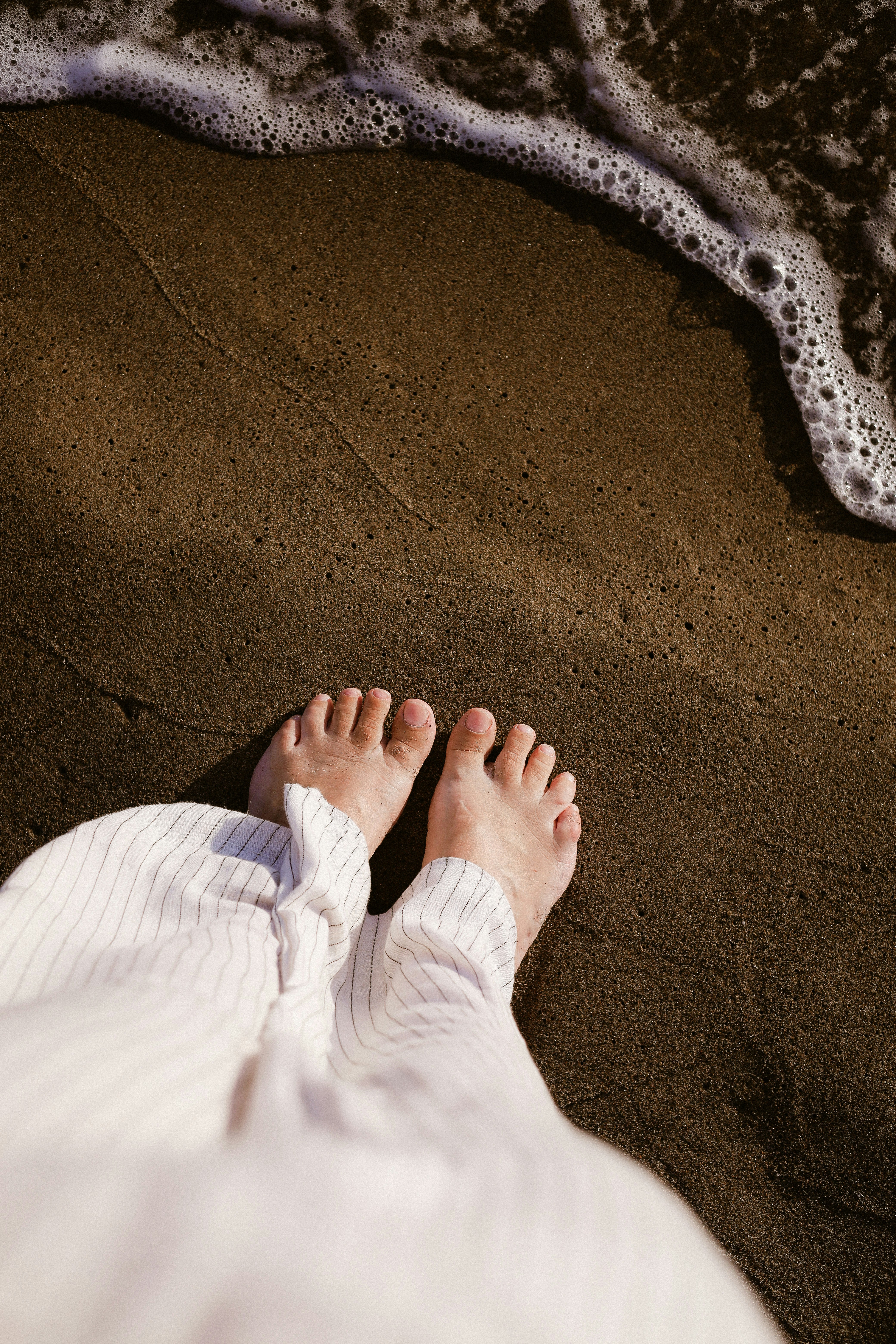 Barefeet at the Shoreline: Sand, Surf, and Soft Light