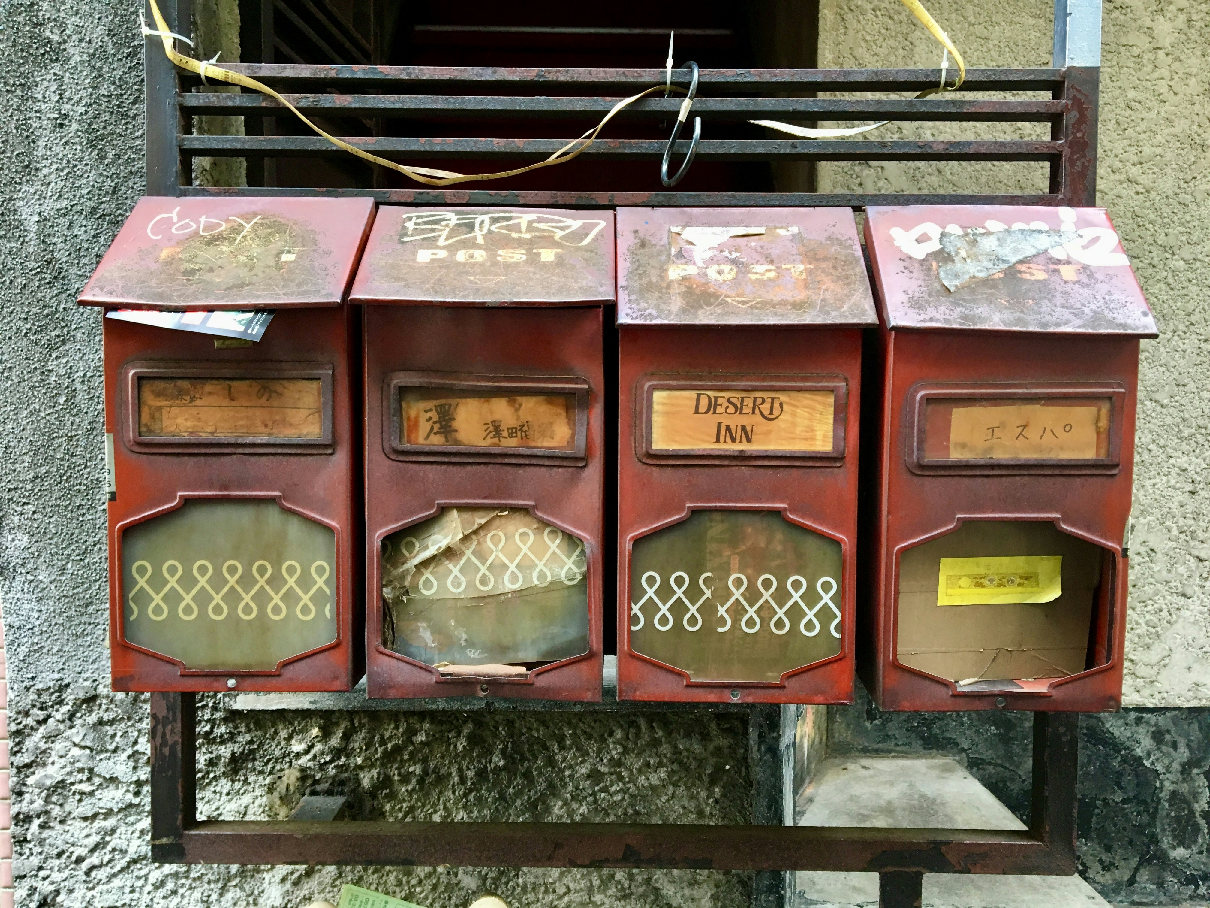 Rusty Mailbox Quartet Under Graffiti Sky