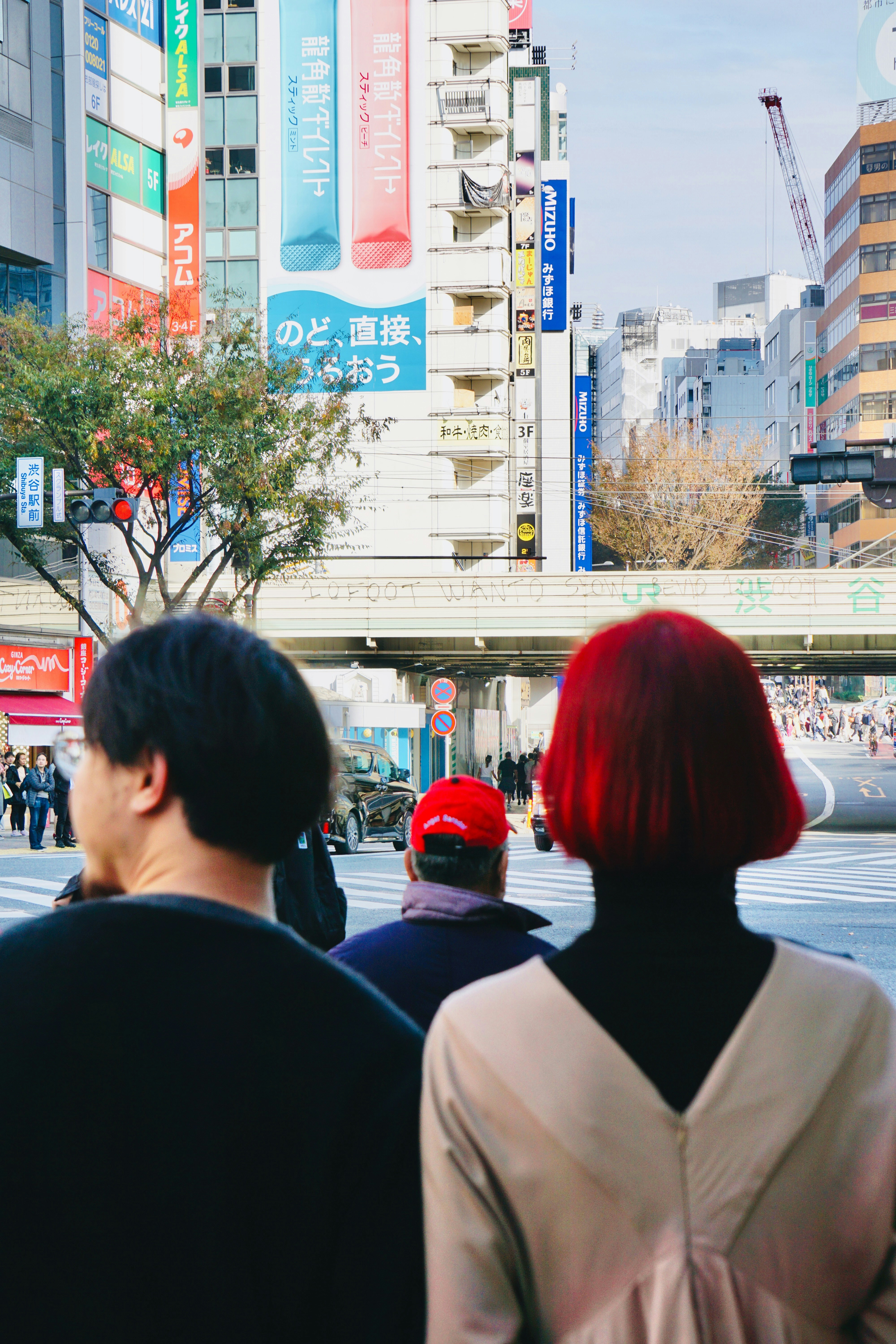 City Crossing: A Red-Haired Moment at Shinjuku