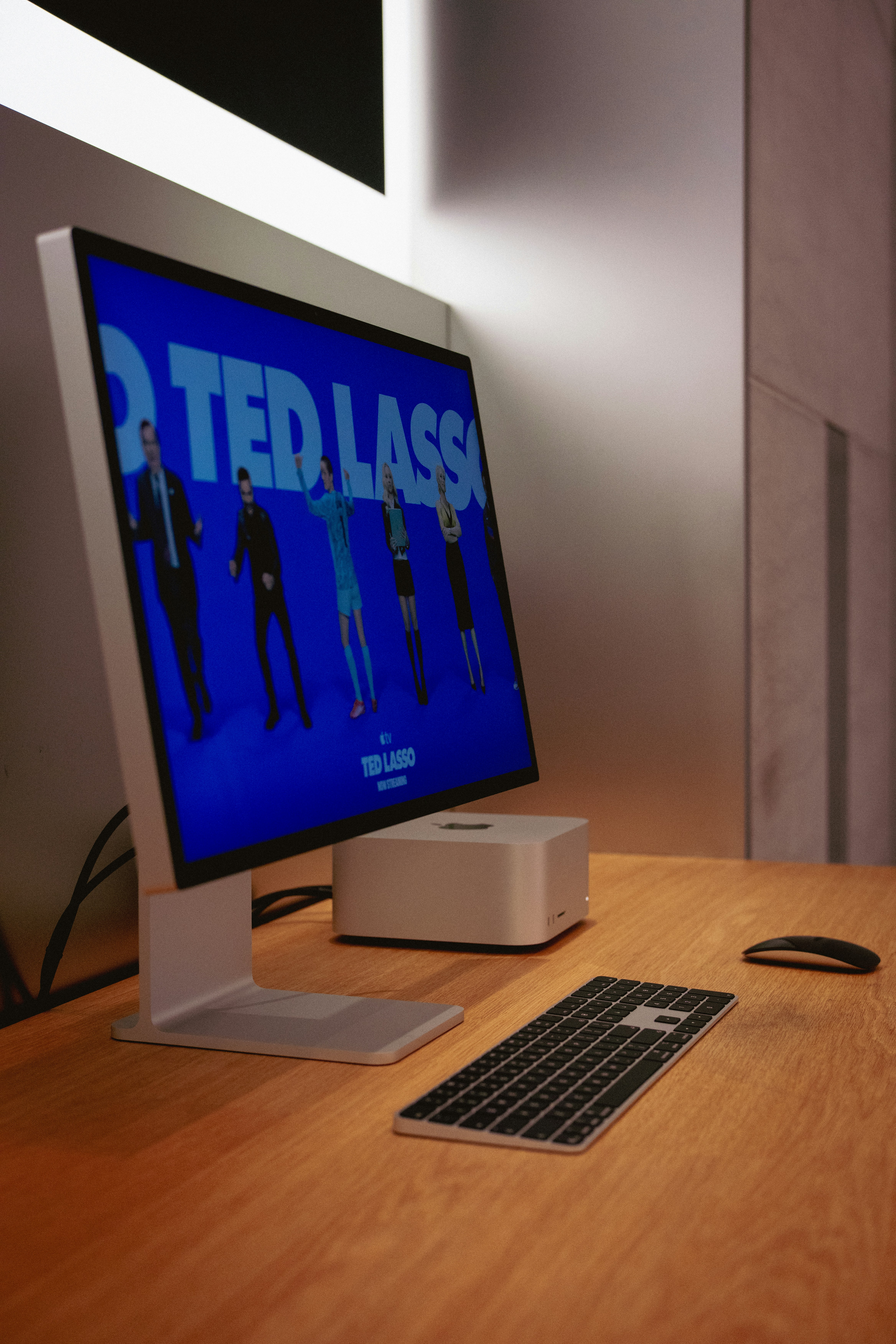 Precise Pixel Play: A Studio Desktop Setup with a Blue-Tinted Monitor