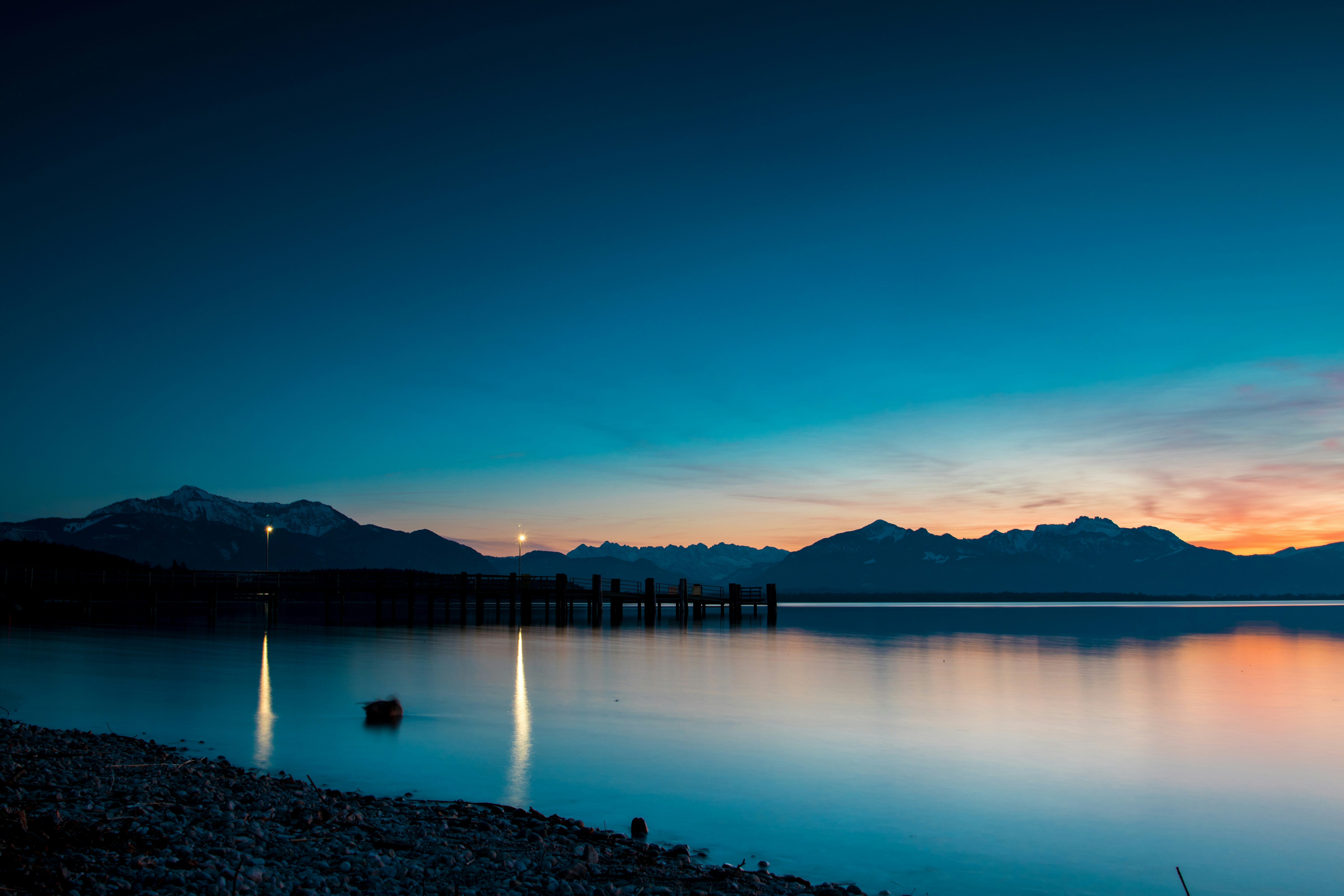 Dawn's Quiet Gap: Mountain Range Over a Glassy Lake