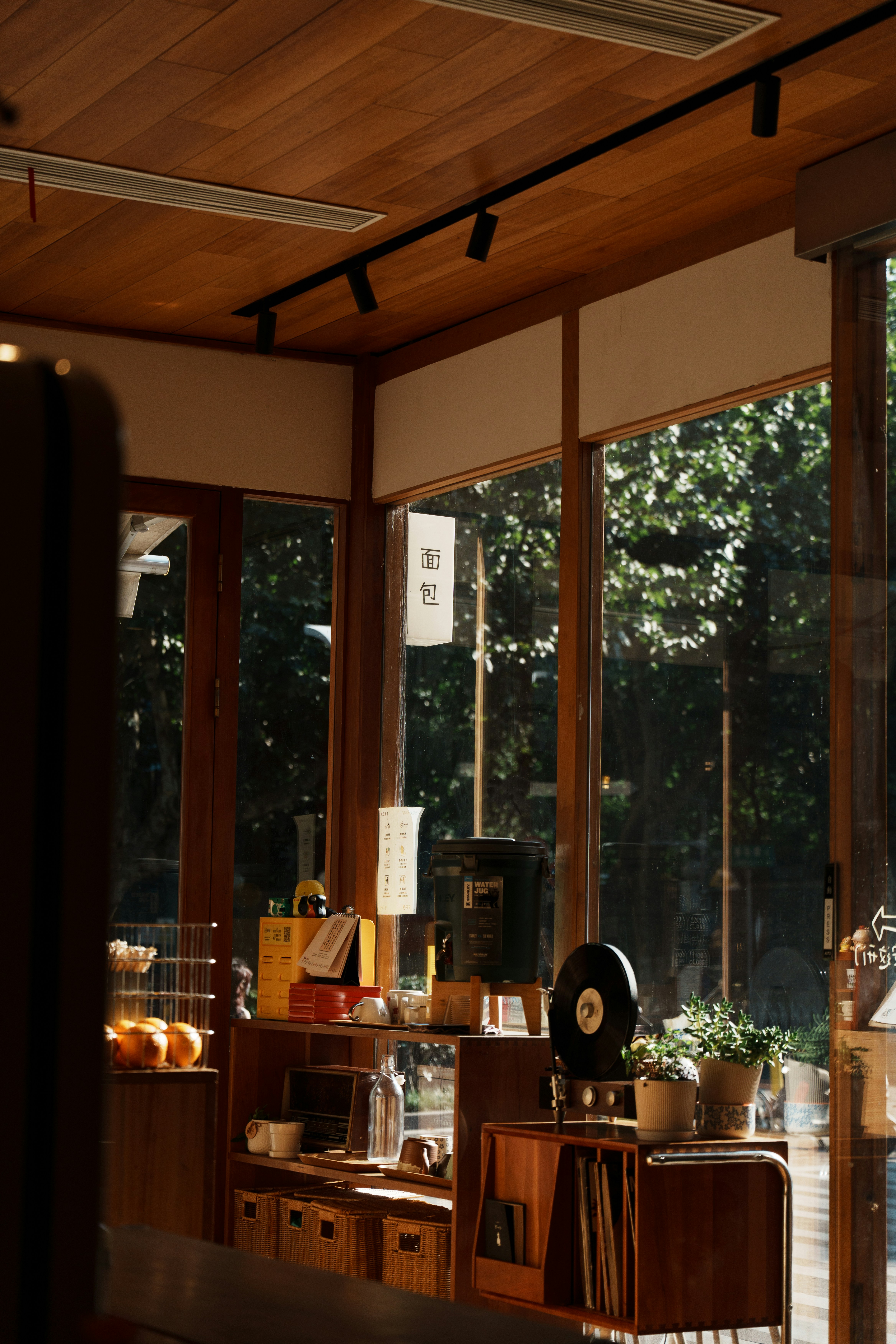 Sunlit Café Interior with Wooden Craft and Glass Doorways