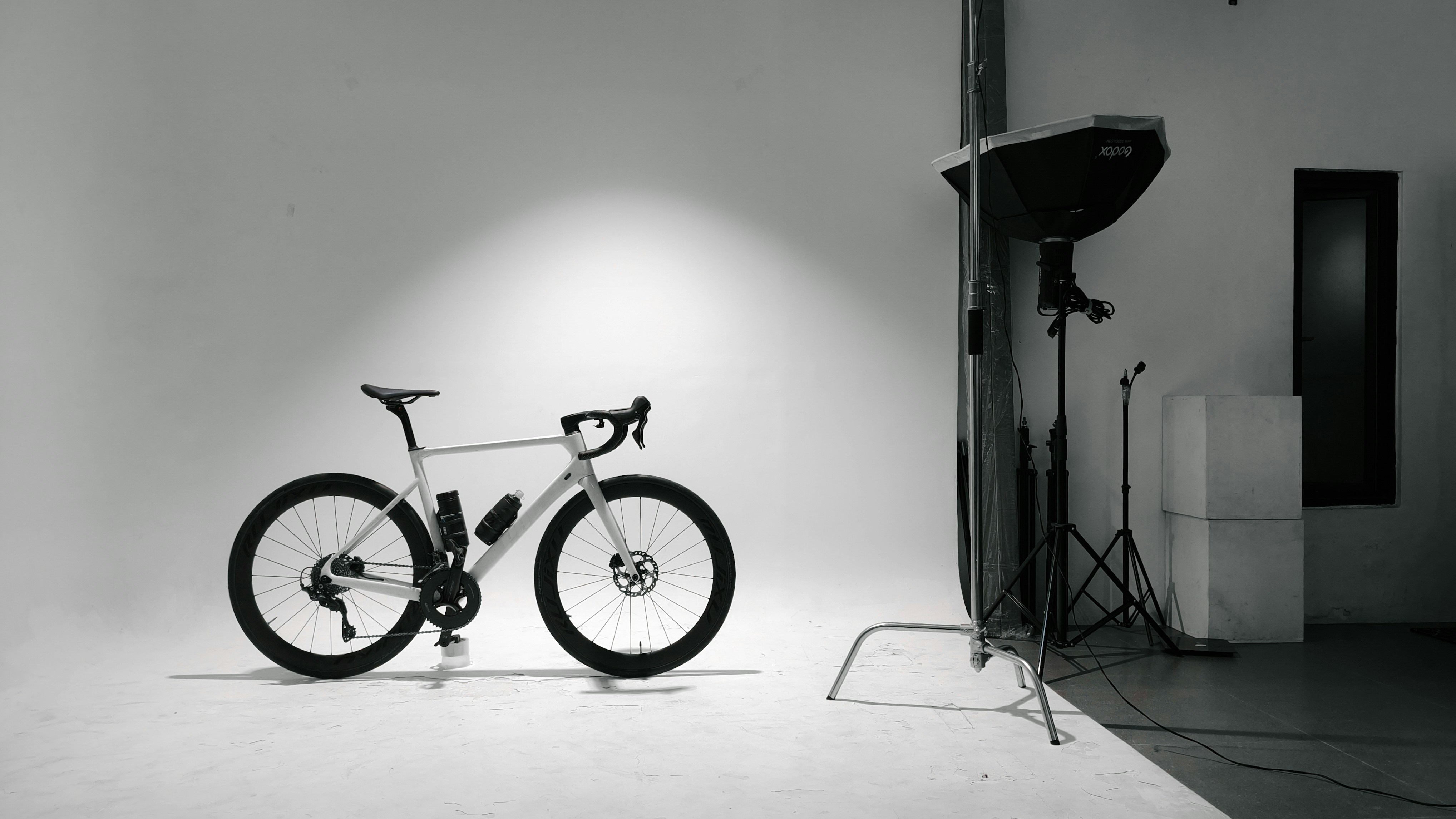 Minimal Studio Grit: A White Bicycle Under a Spotlight