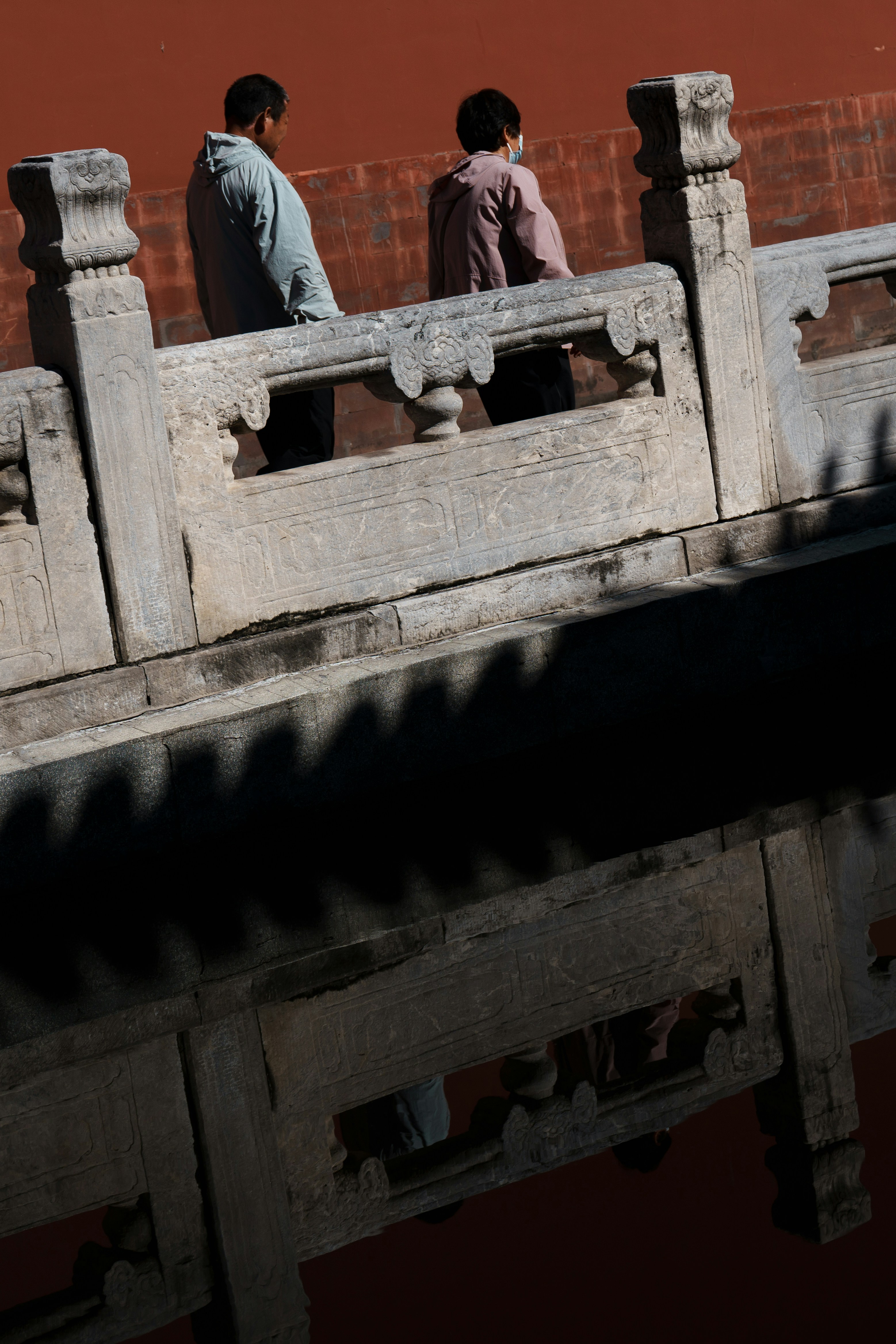 Guardians of the Bridge: Silhouettes Over Stone and Red