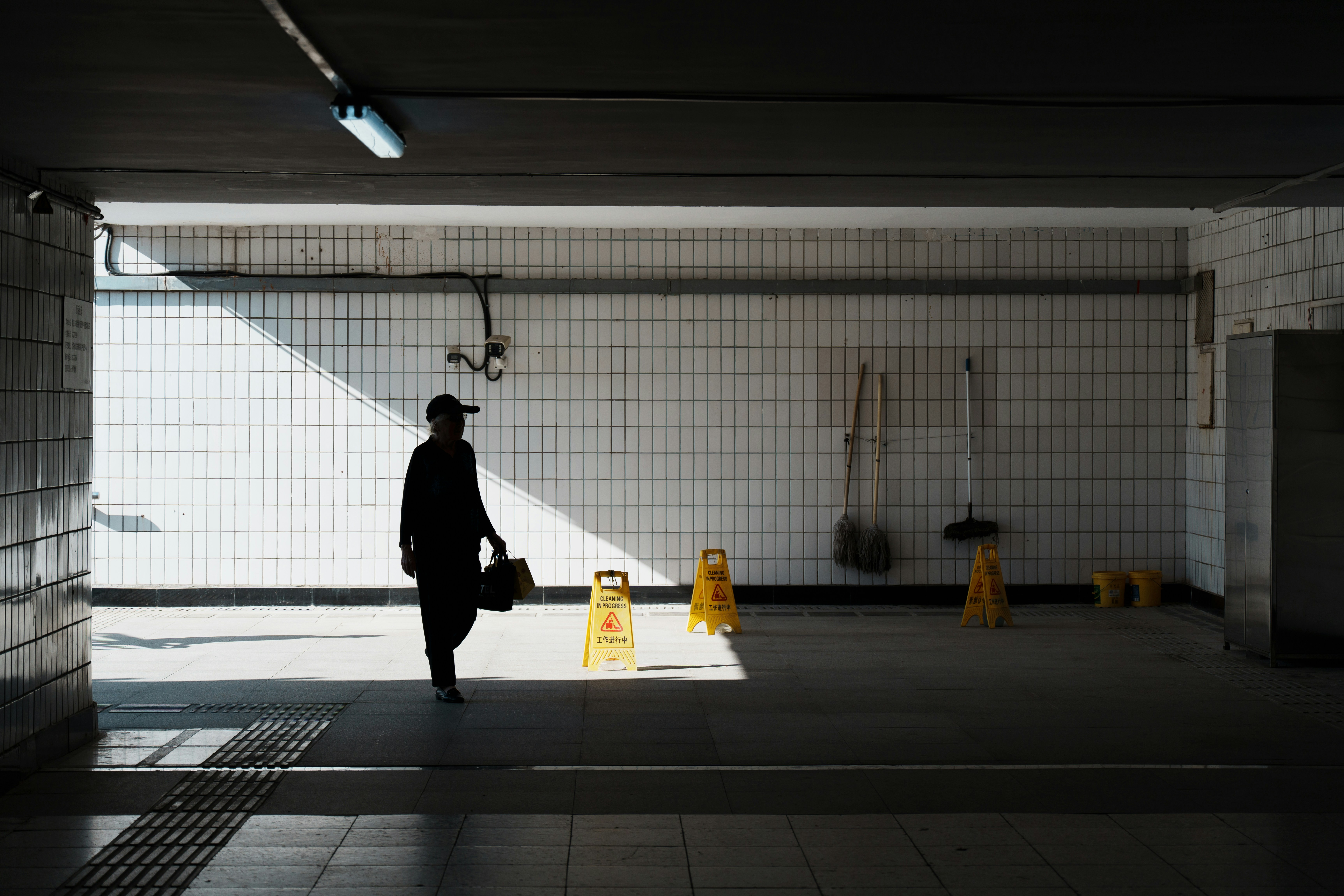 Silhouette in the Neon-tiled Corridor